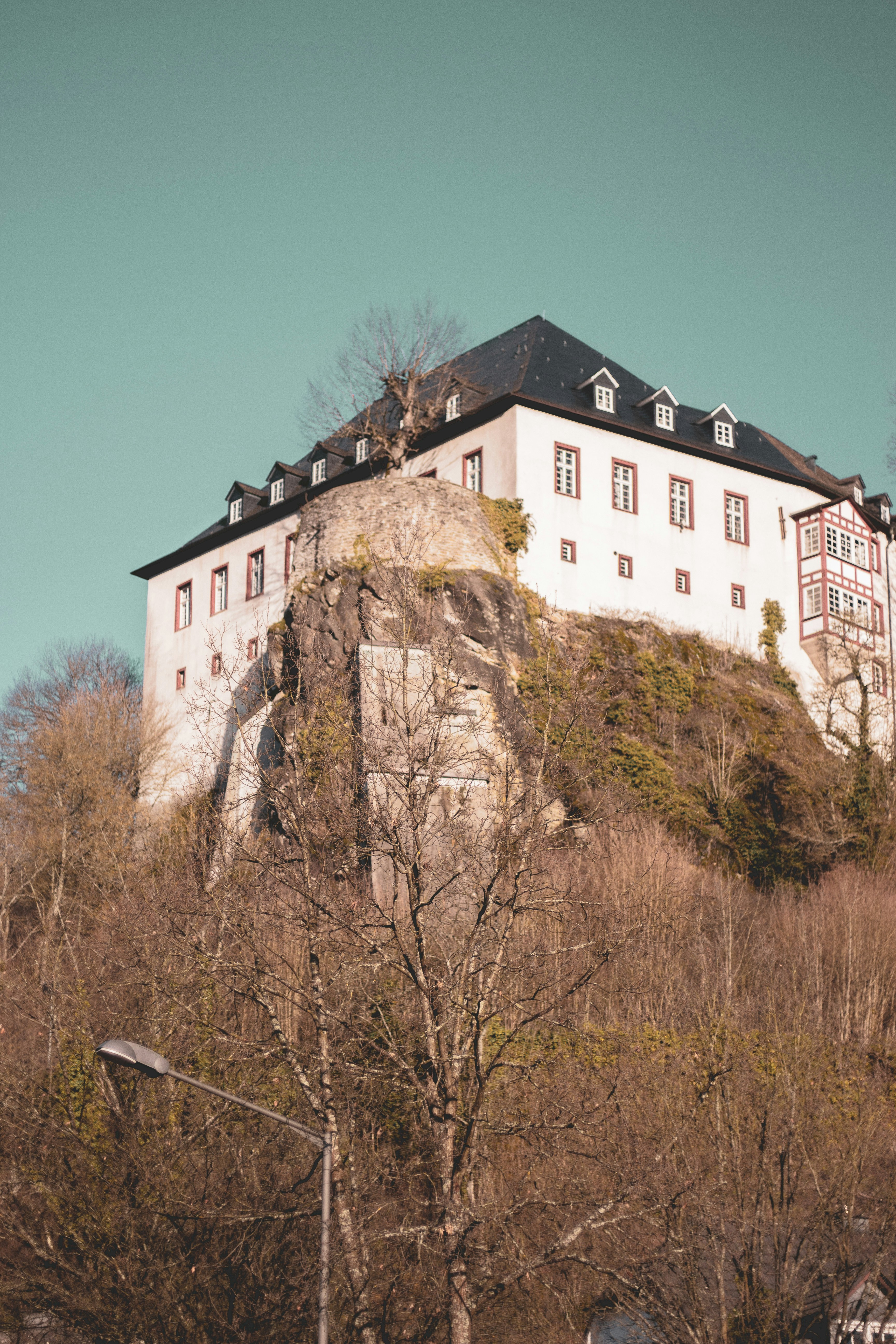 White and black concrete house surrounded by trees during daytime photo ...