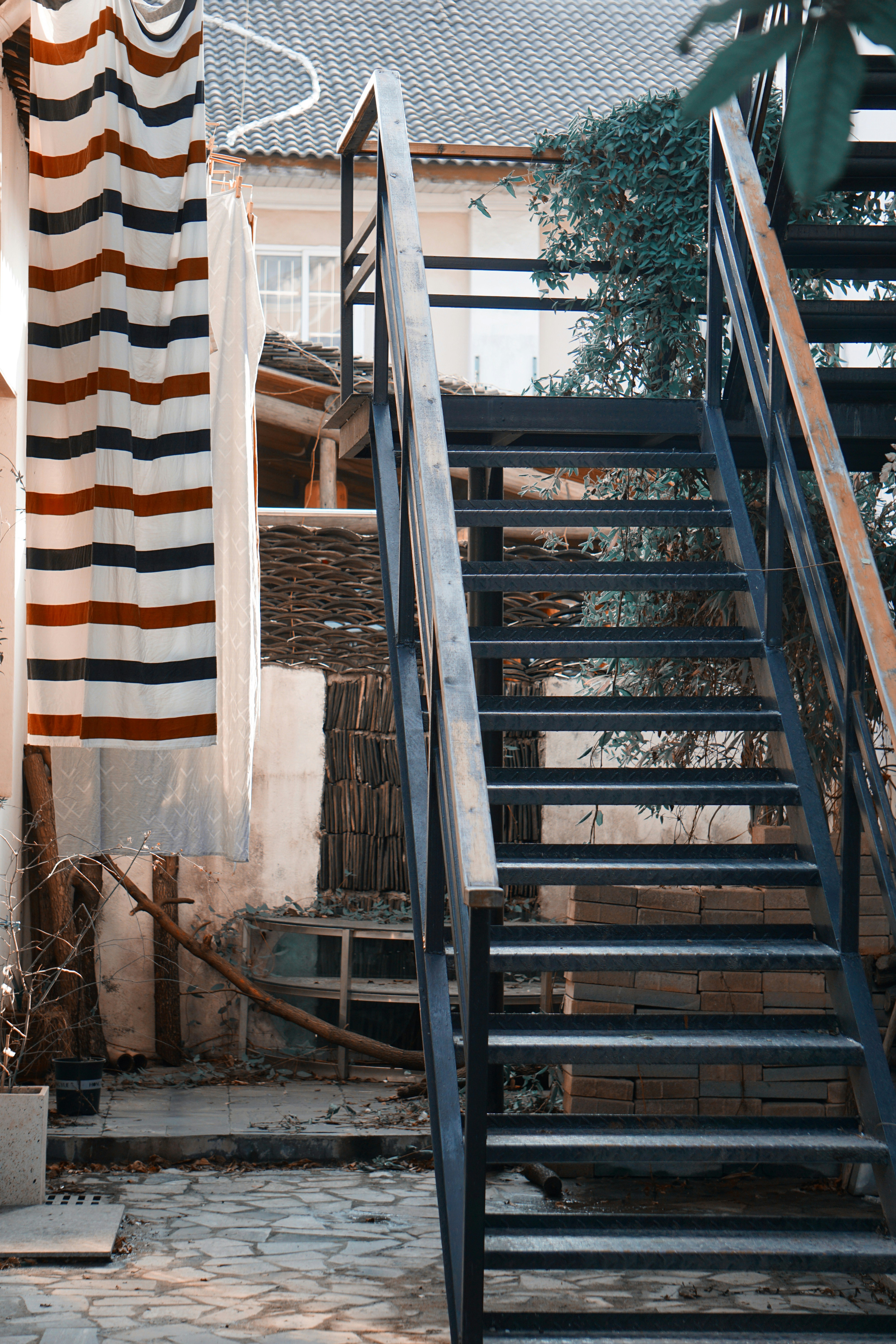 Staircase Veil: Laundry Lines and Shadowed Courtyard