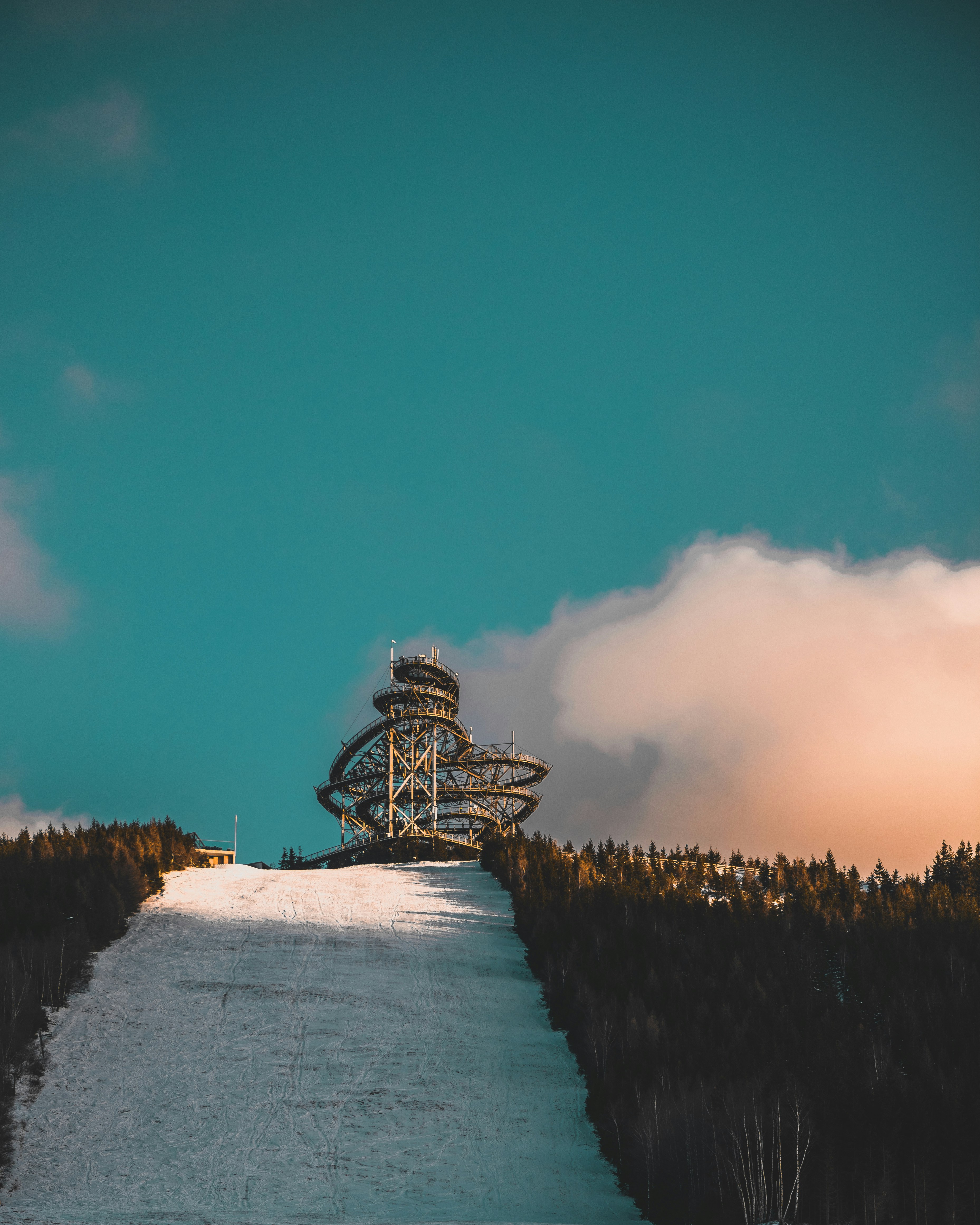 Snowbound Tower: A Spiral at Dusk Above a Quiet Crest