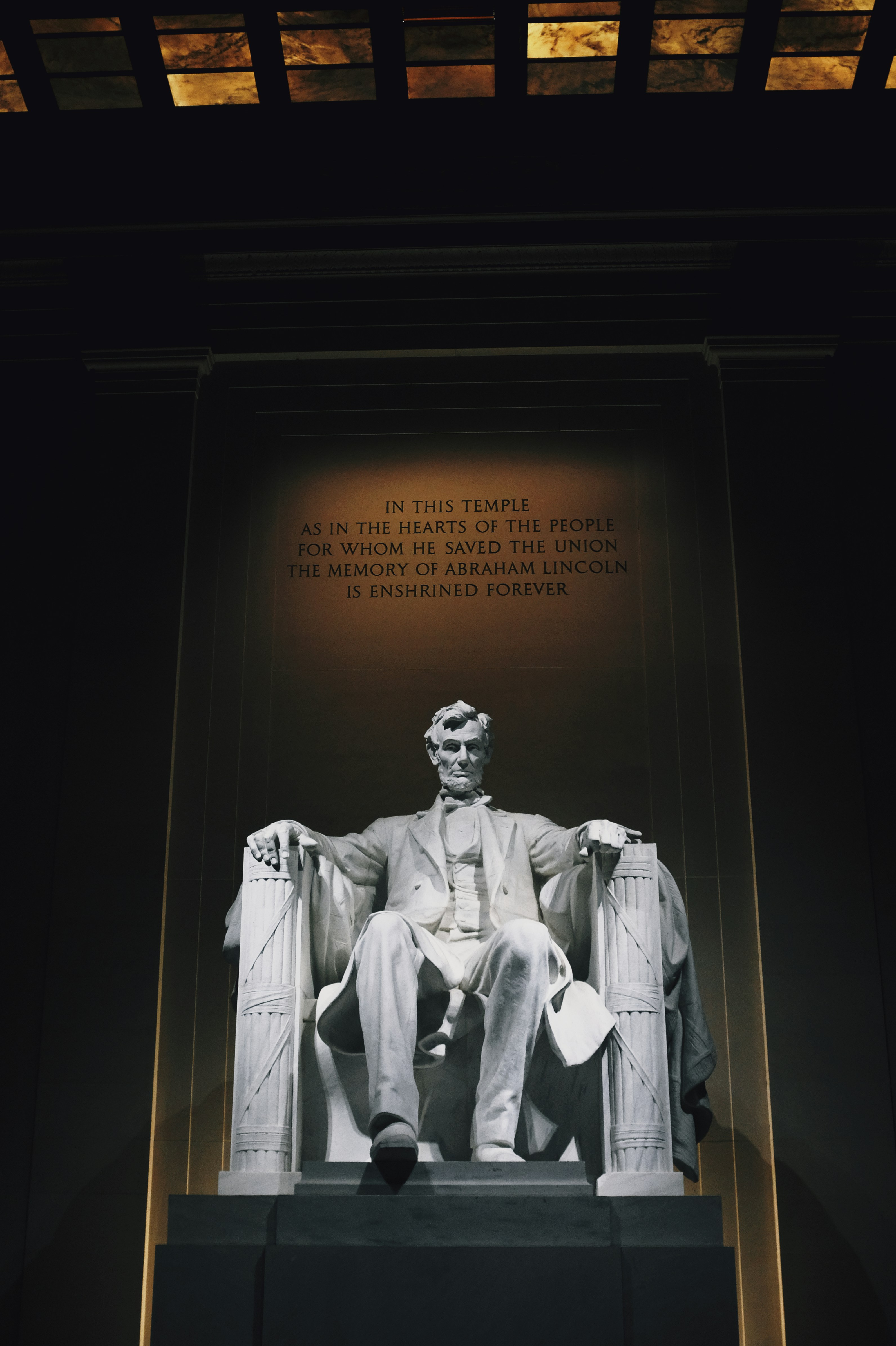 Quiet Colossus: Lincoln's Seated Vigil in a Dim Hall