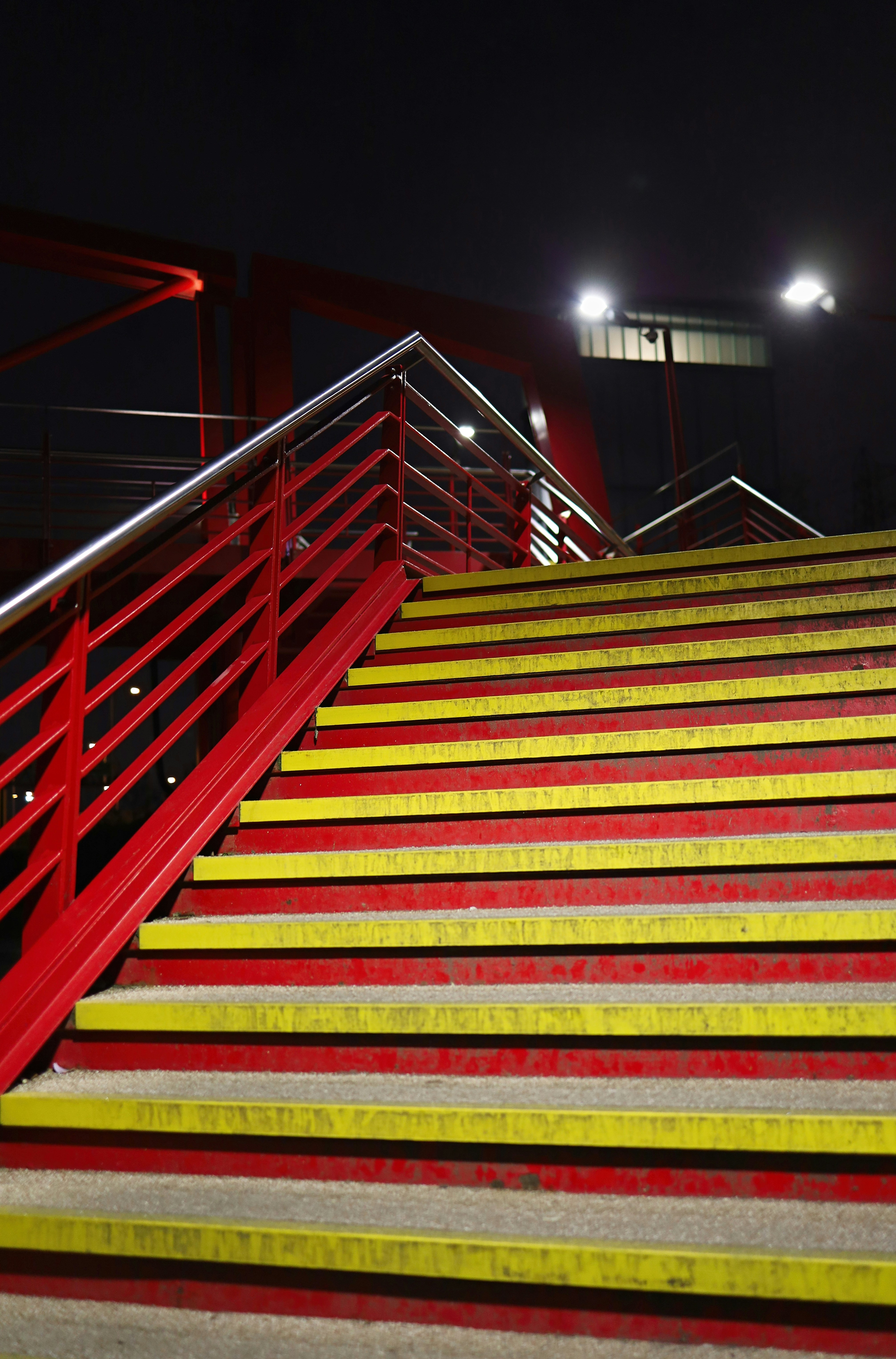 A set of stairs with yellow and red steps photo – Free Staircase Image ...