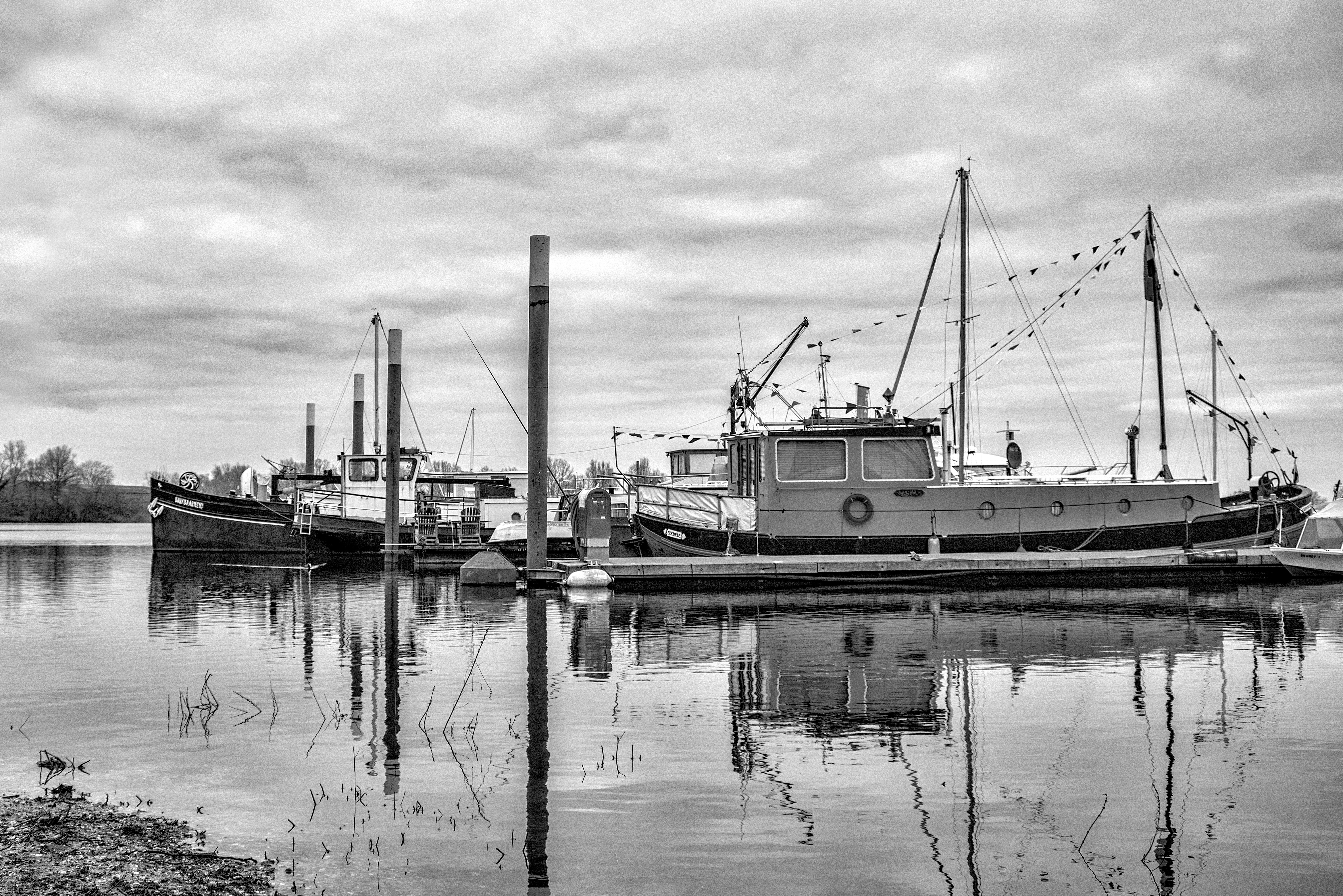 Grayscale photography of boats on body of water near buildings photo ...