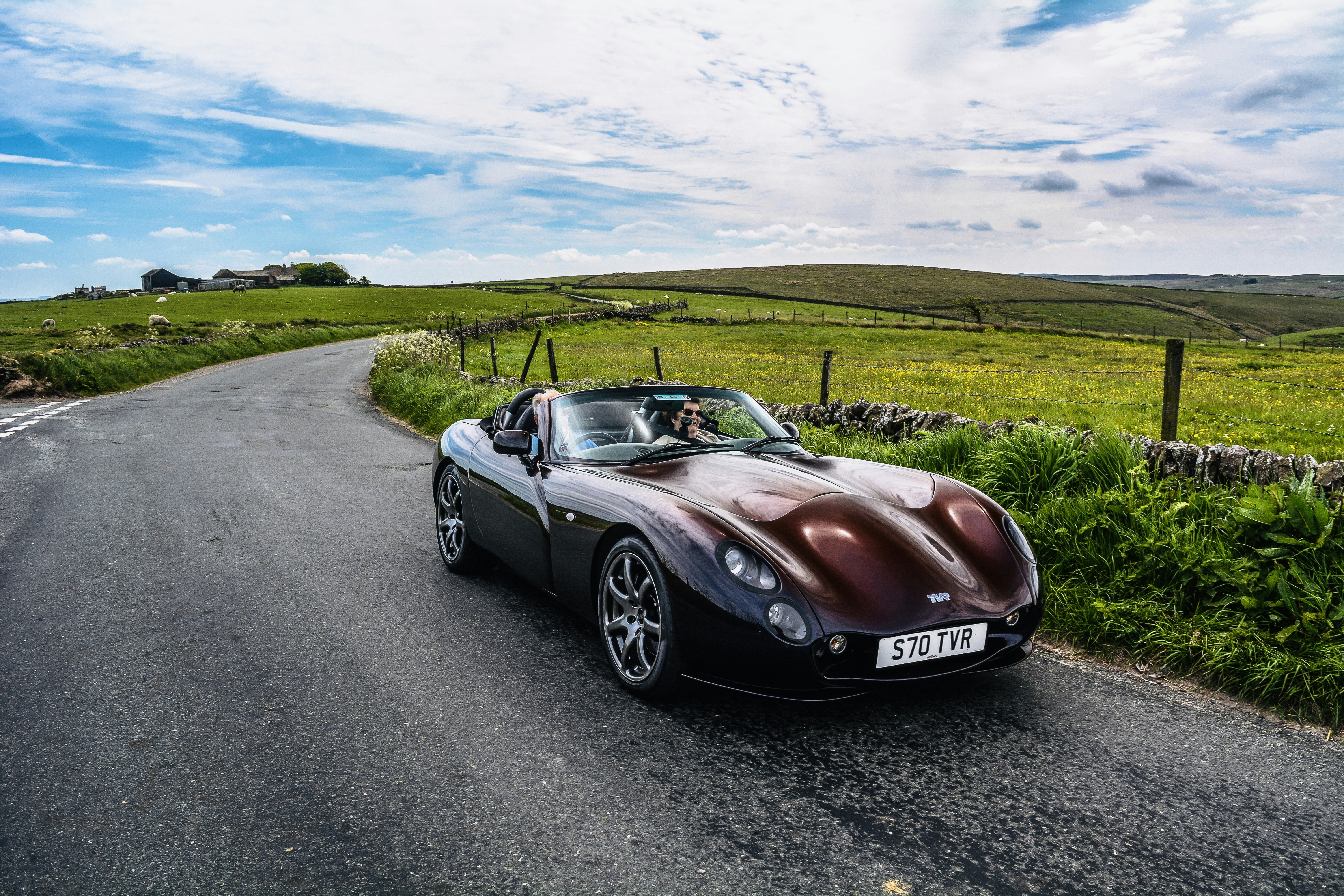 Red convertible coupe parking near road under white and blue sky photo ...