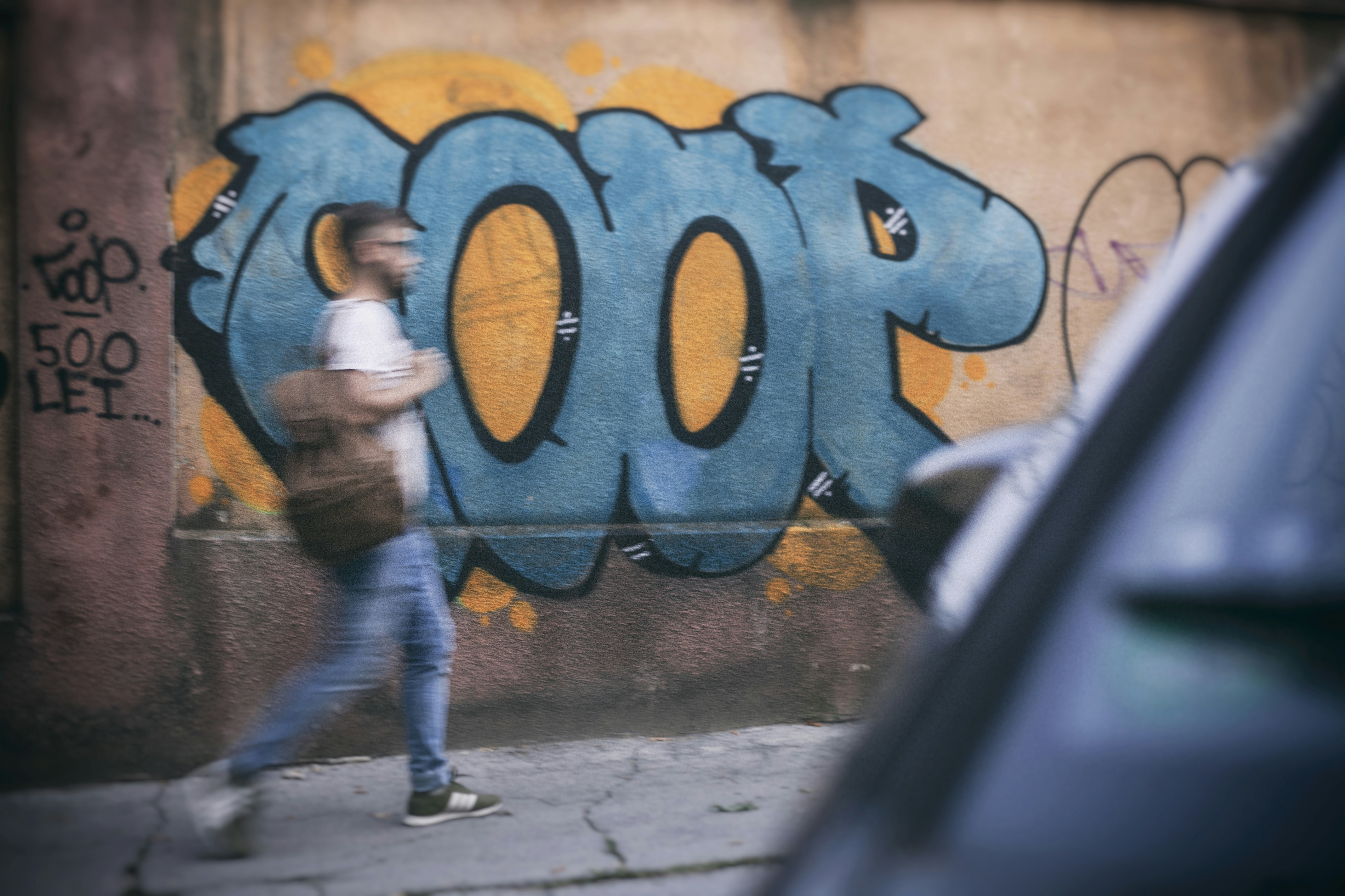 Passing by Graffiti: The Blur of a City Walk