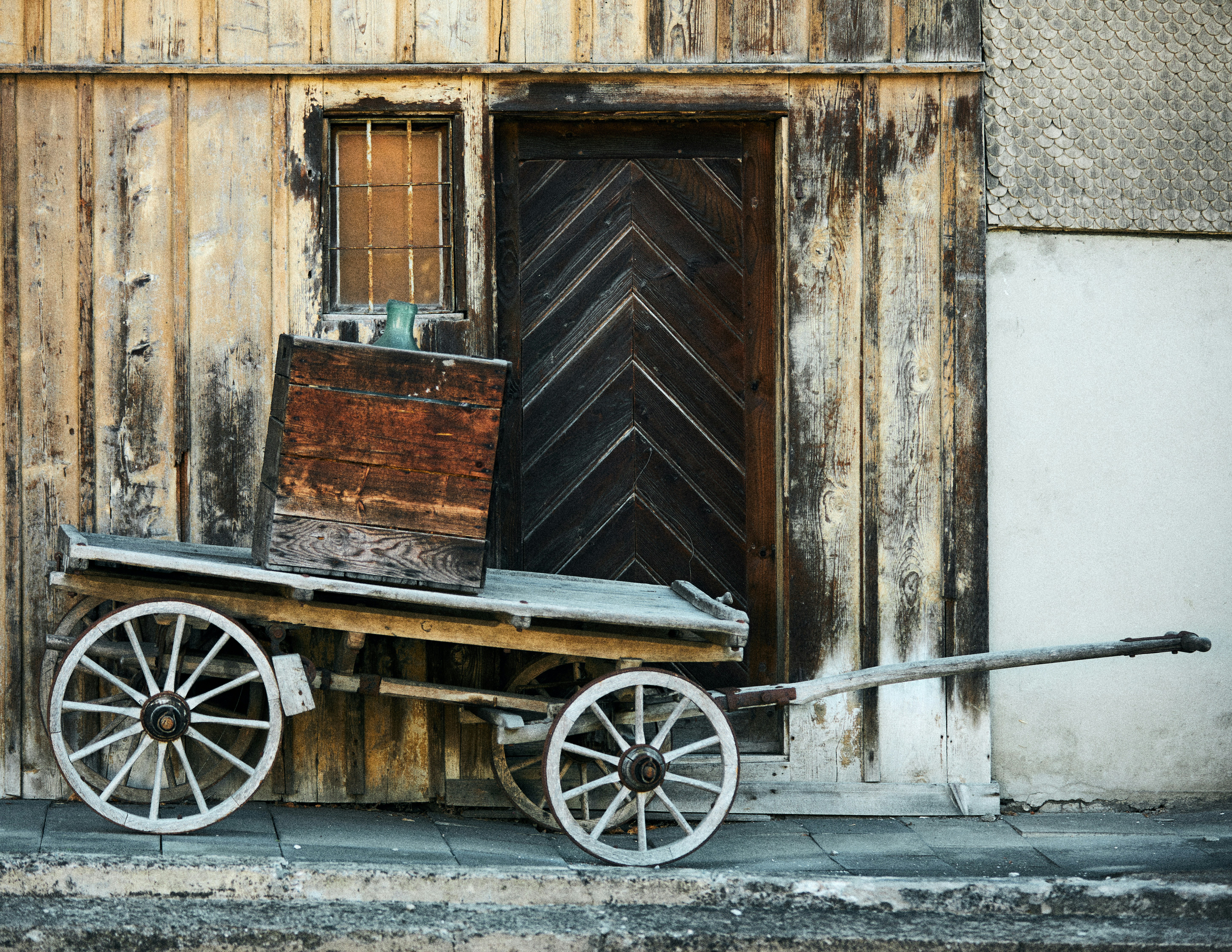 Chevron Door and Weathered Wagon: A Timber Facade Portrait
