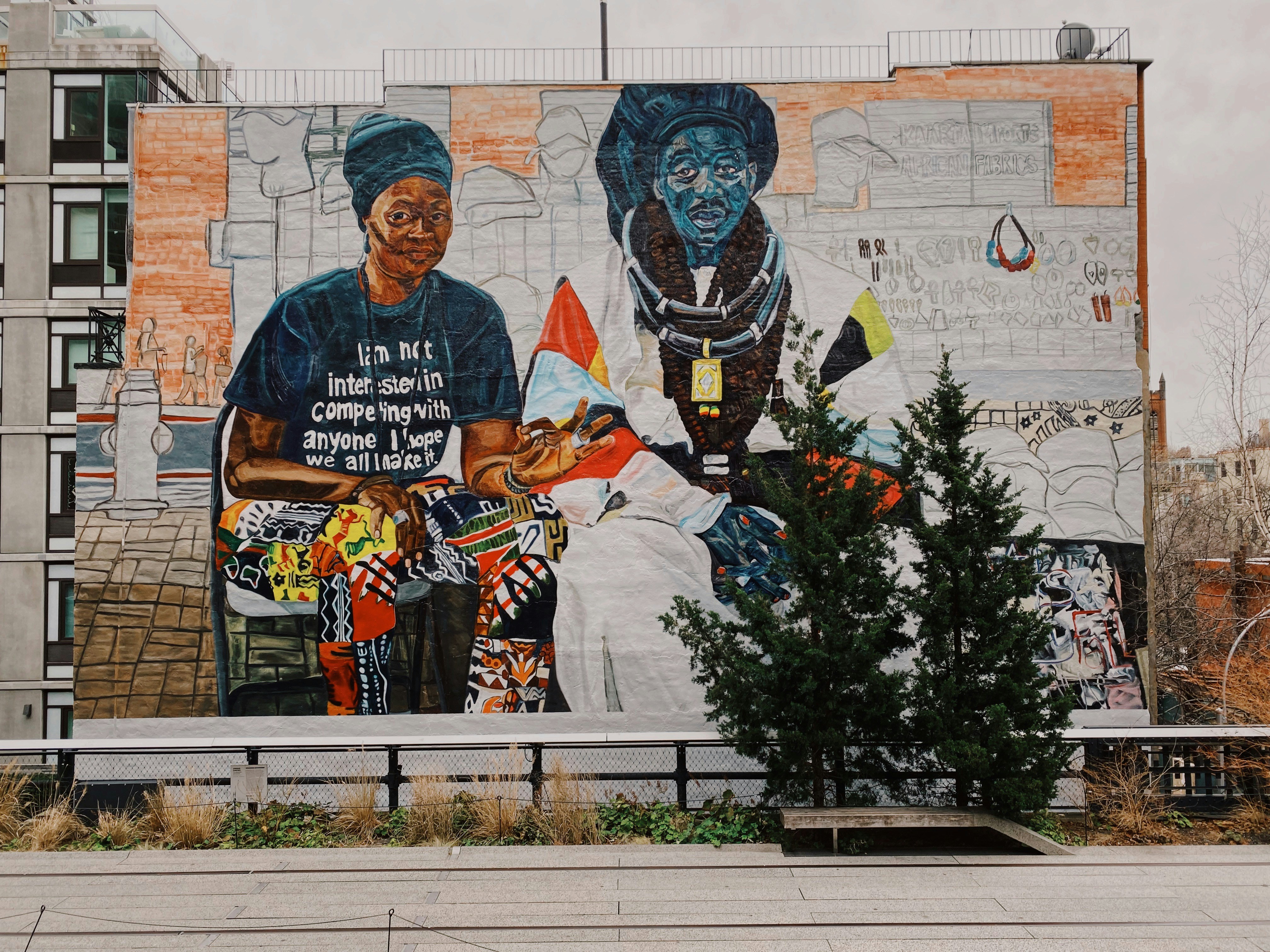 Urban mural: two exuberant figures painted on a large brick wall
