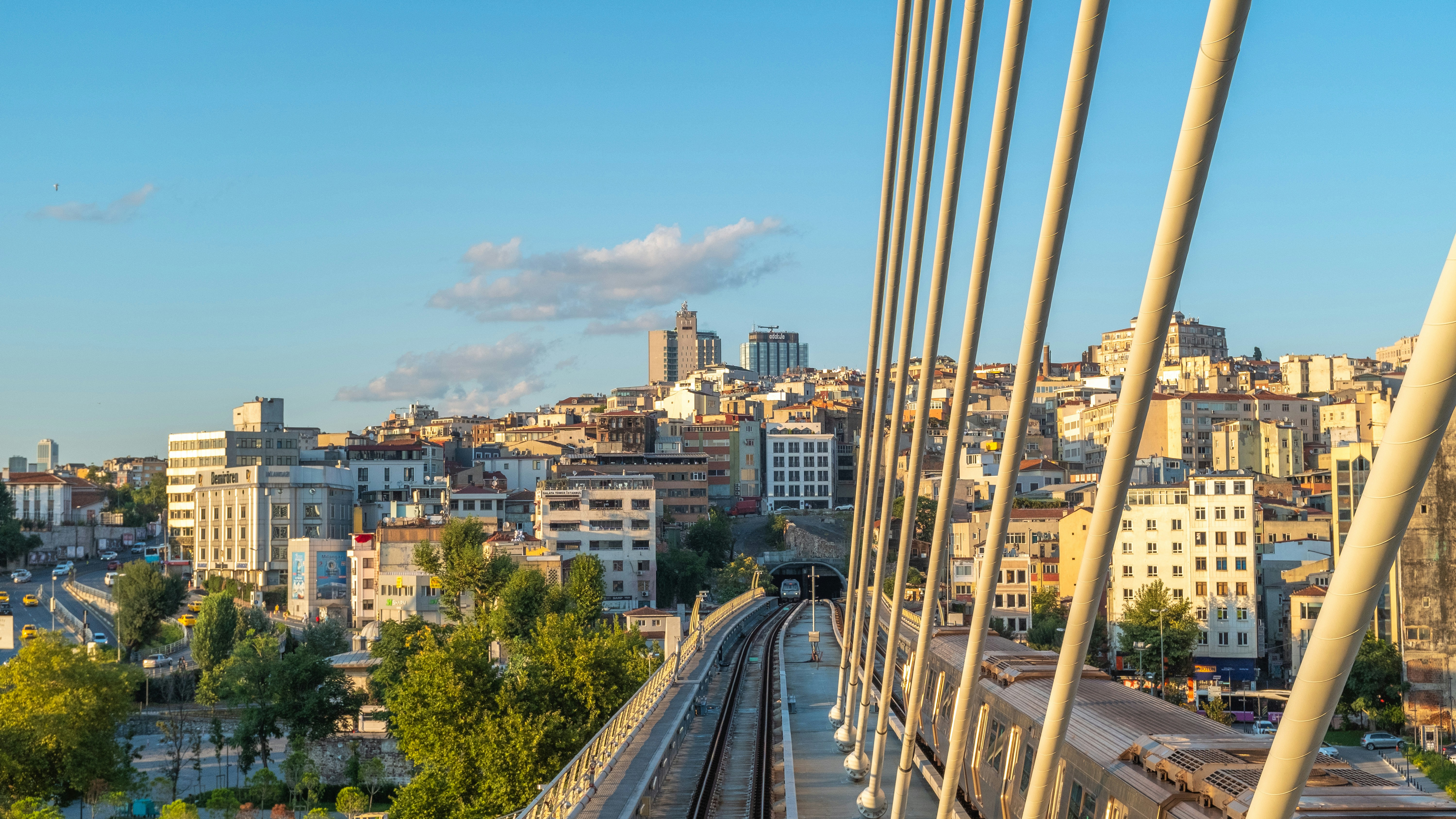 Converging Rails Beneath a Sunlit Cityscape
