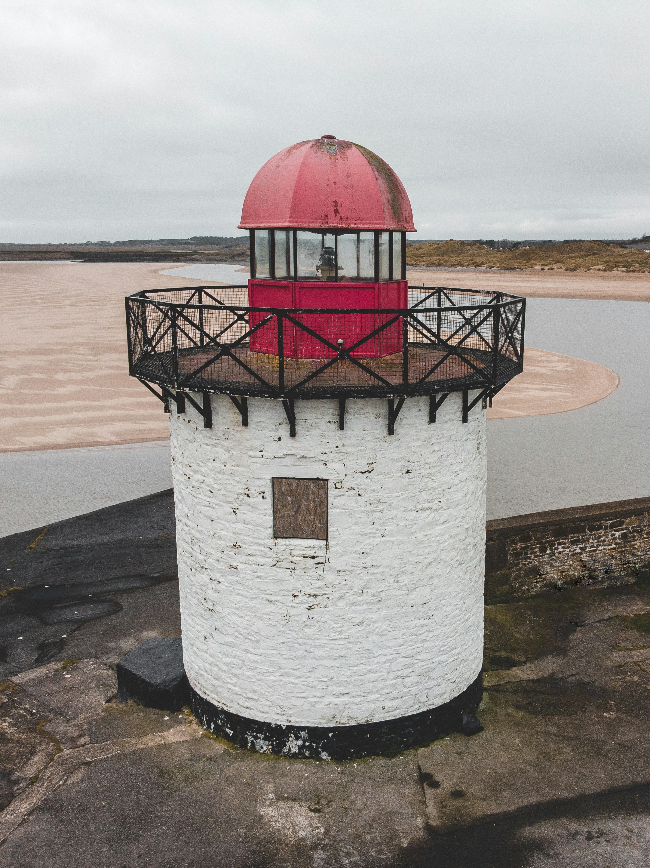 white and red lighthouse photograph