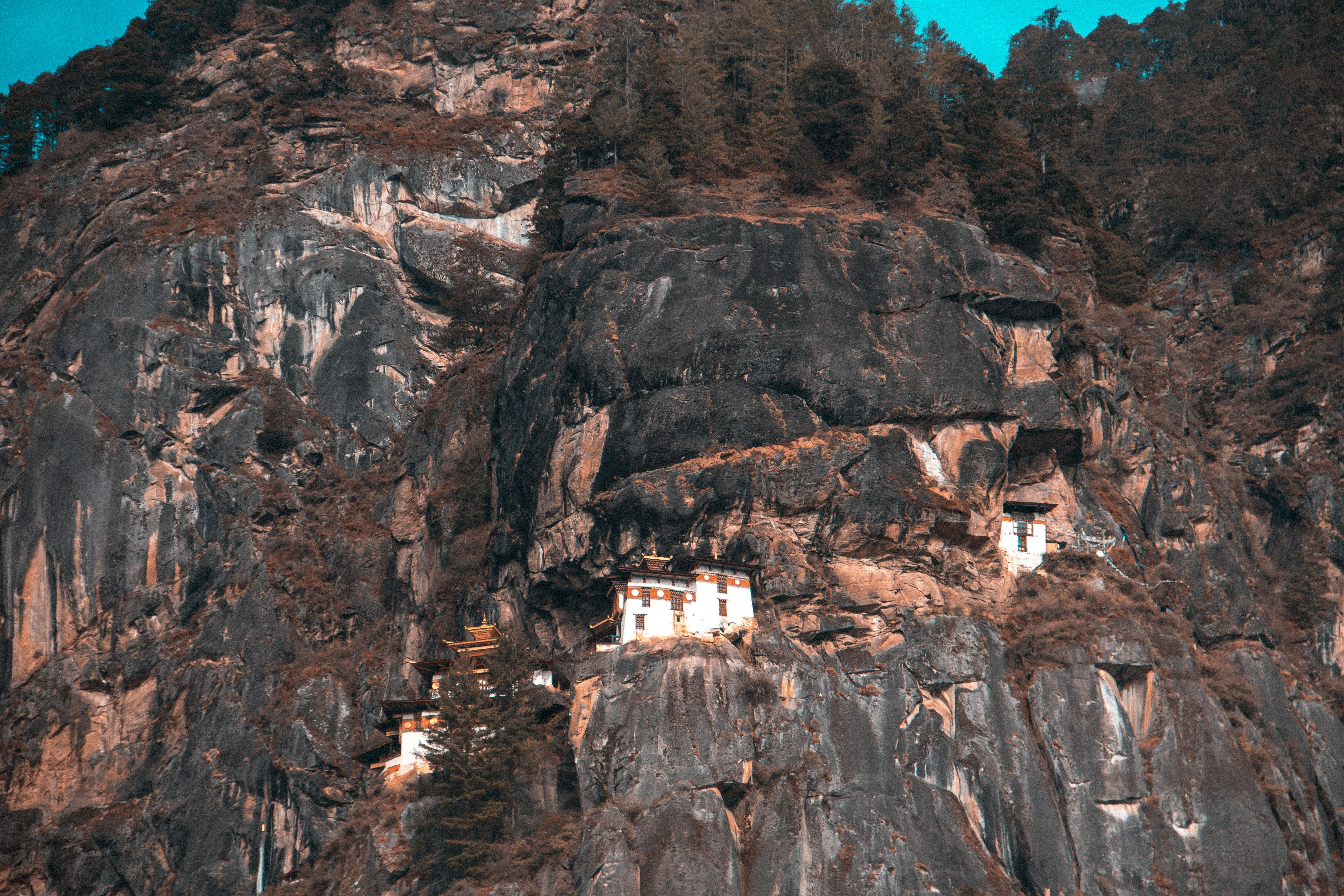 Clifftop Retreats: White Structures Nestled in Granite
