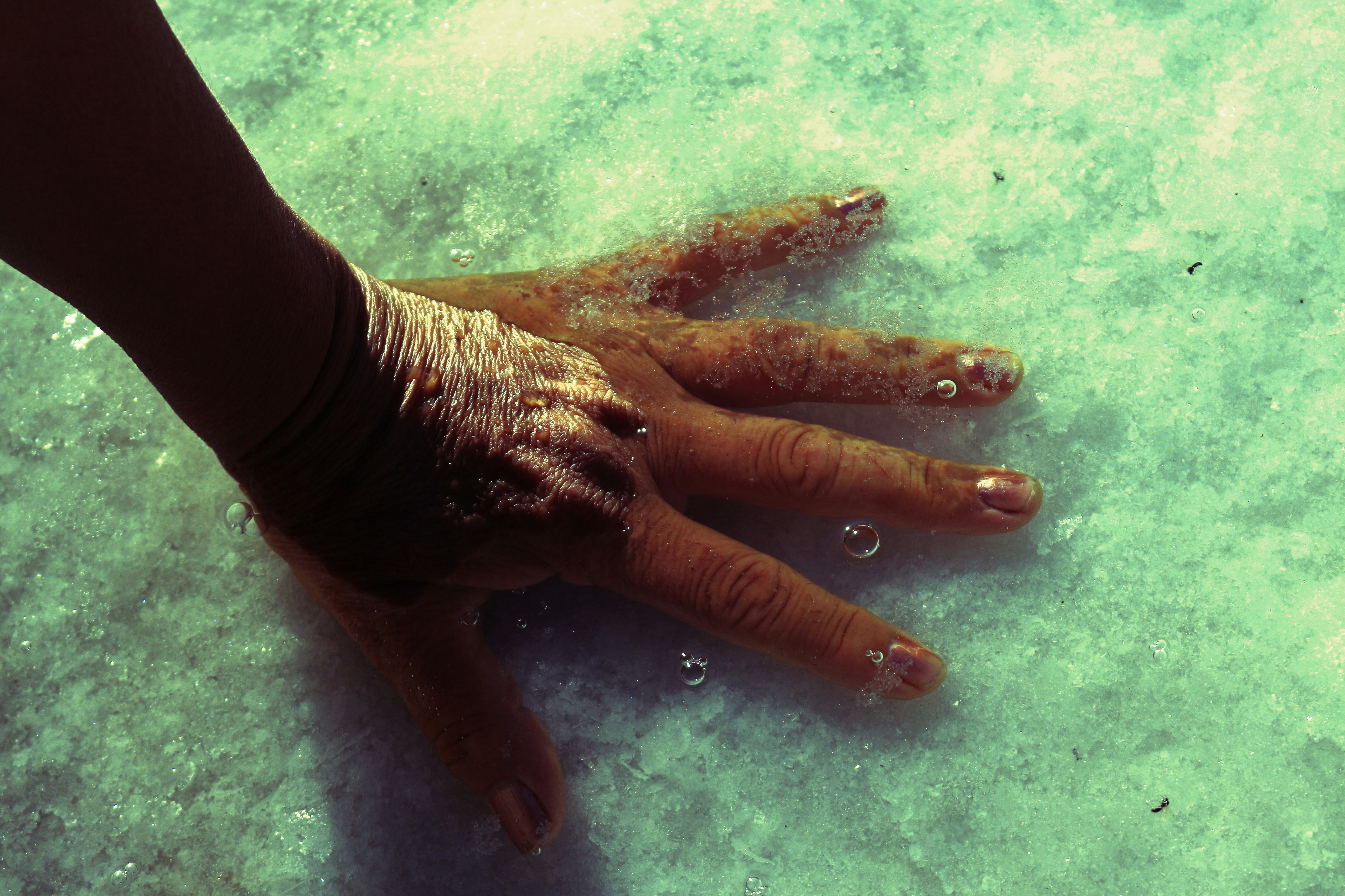 person's hand on white surface