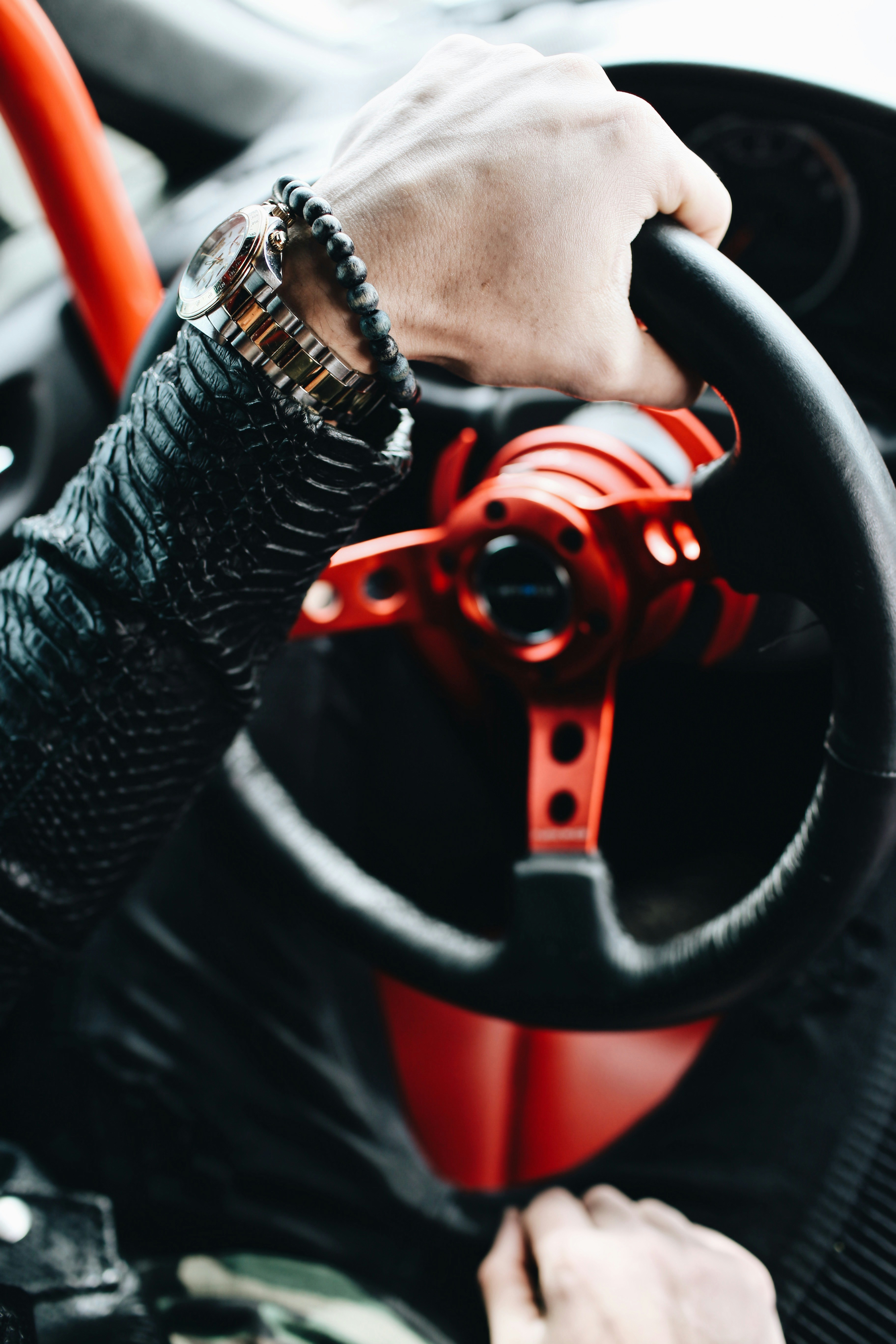 Red Steering: A Driver’s Hand on a Custom Wheel