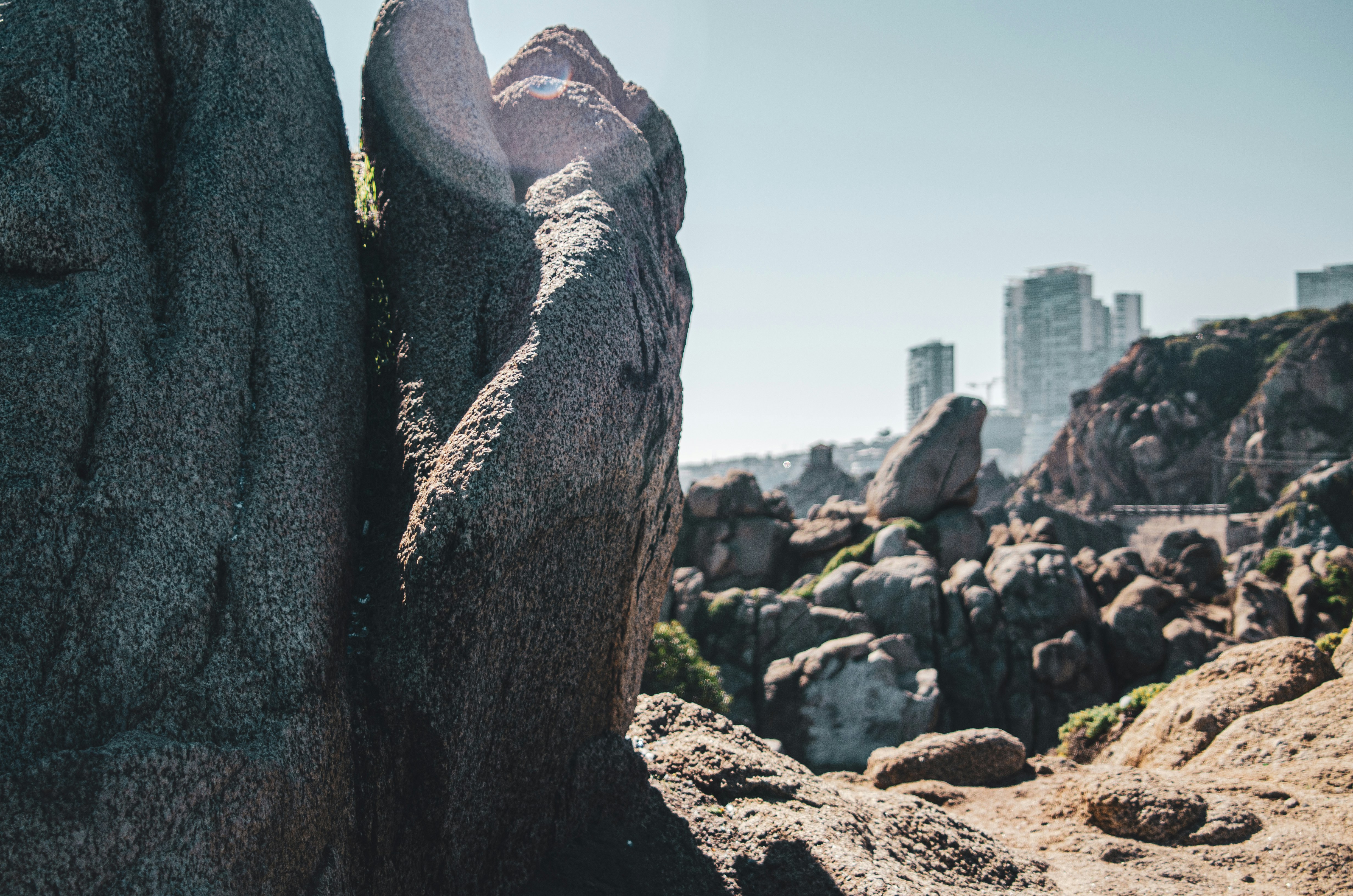 Coastal Granite Portrait: Towering Rocks Guard a Sunlit Promenade