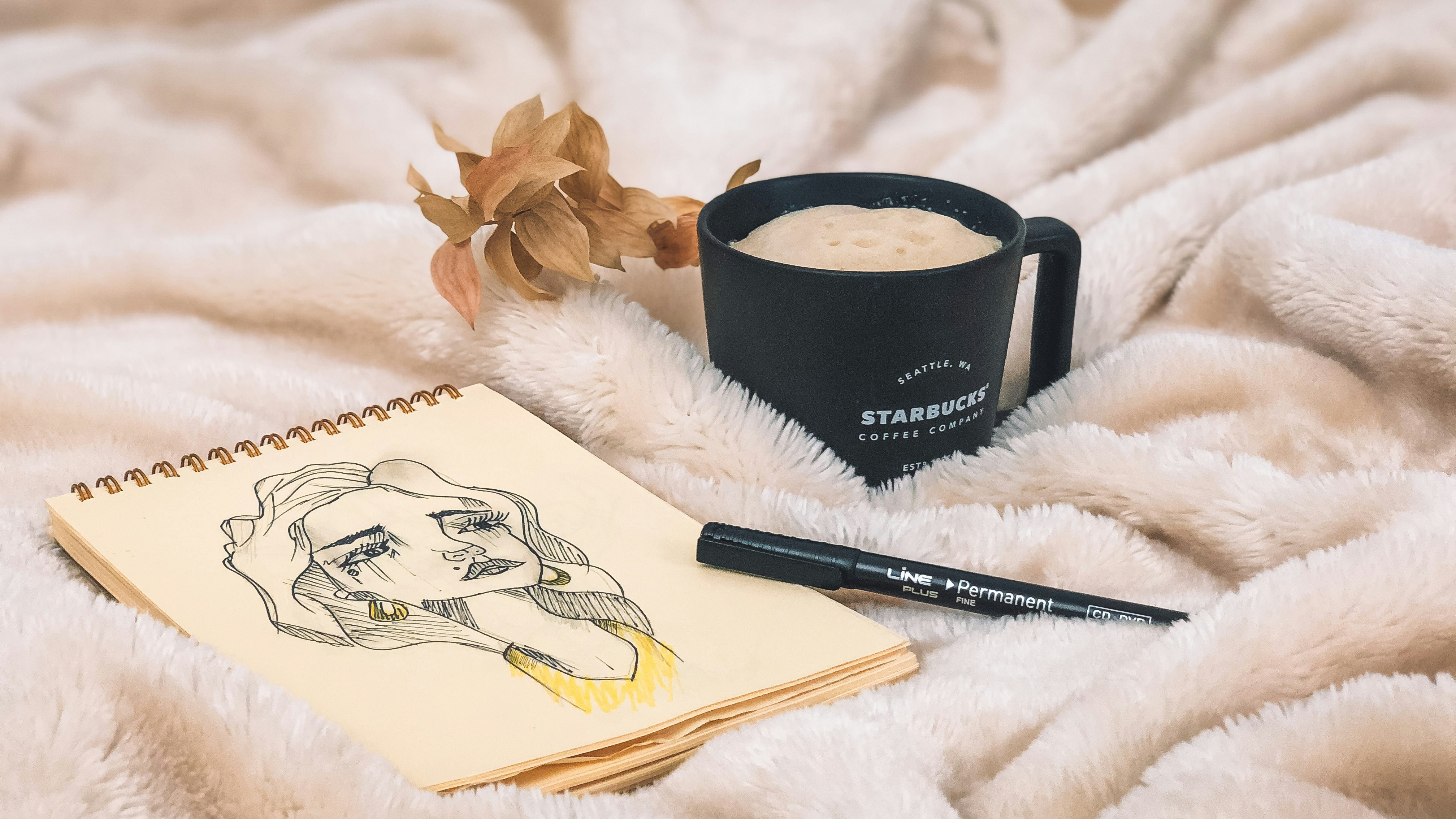 black mug near notebook
