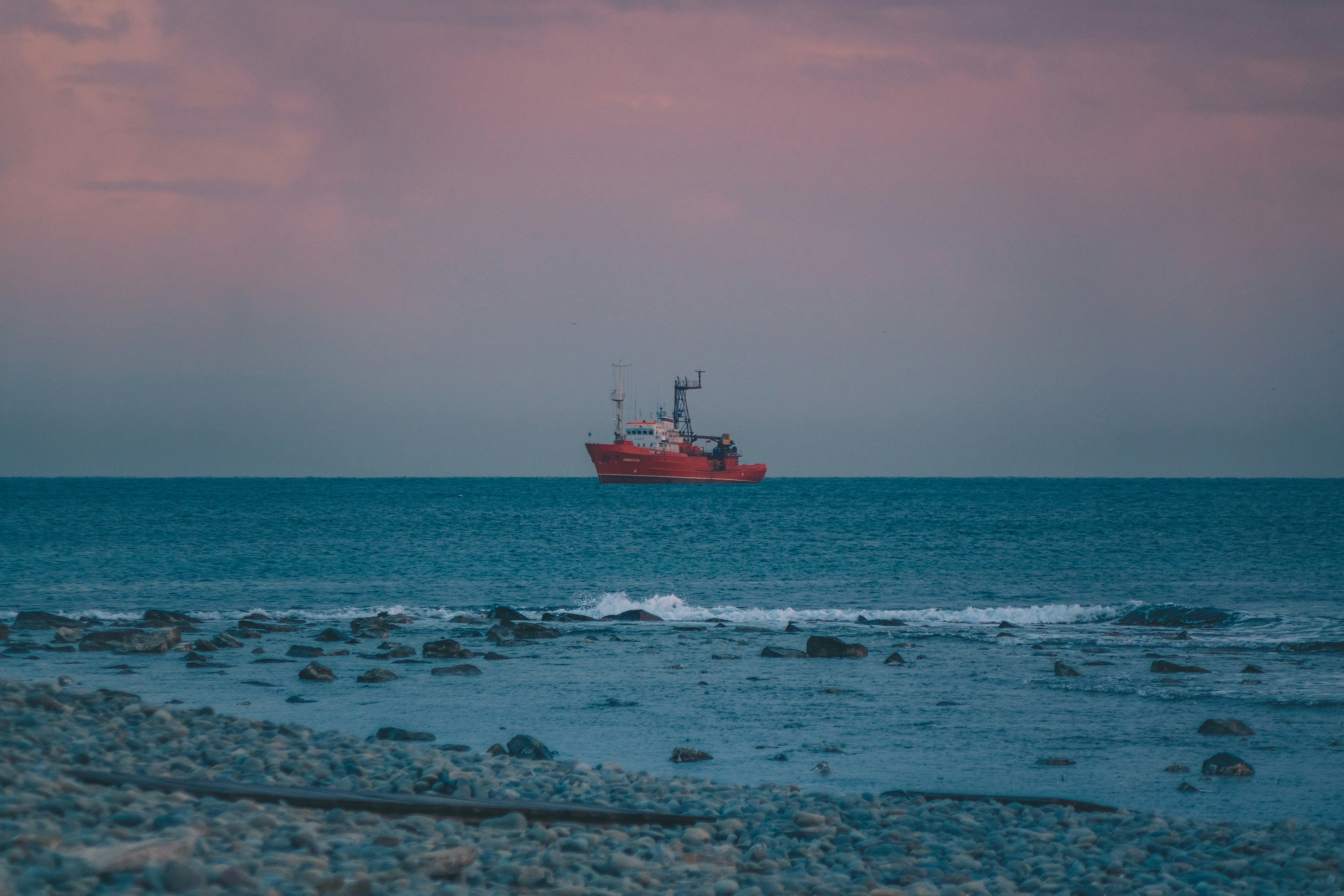 Red sailing ship on sea photo – Free Grey Image on Unsplash