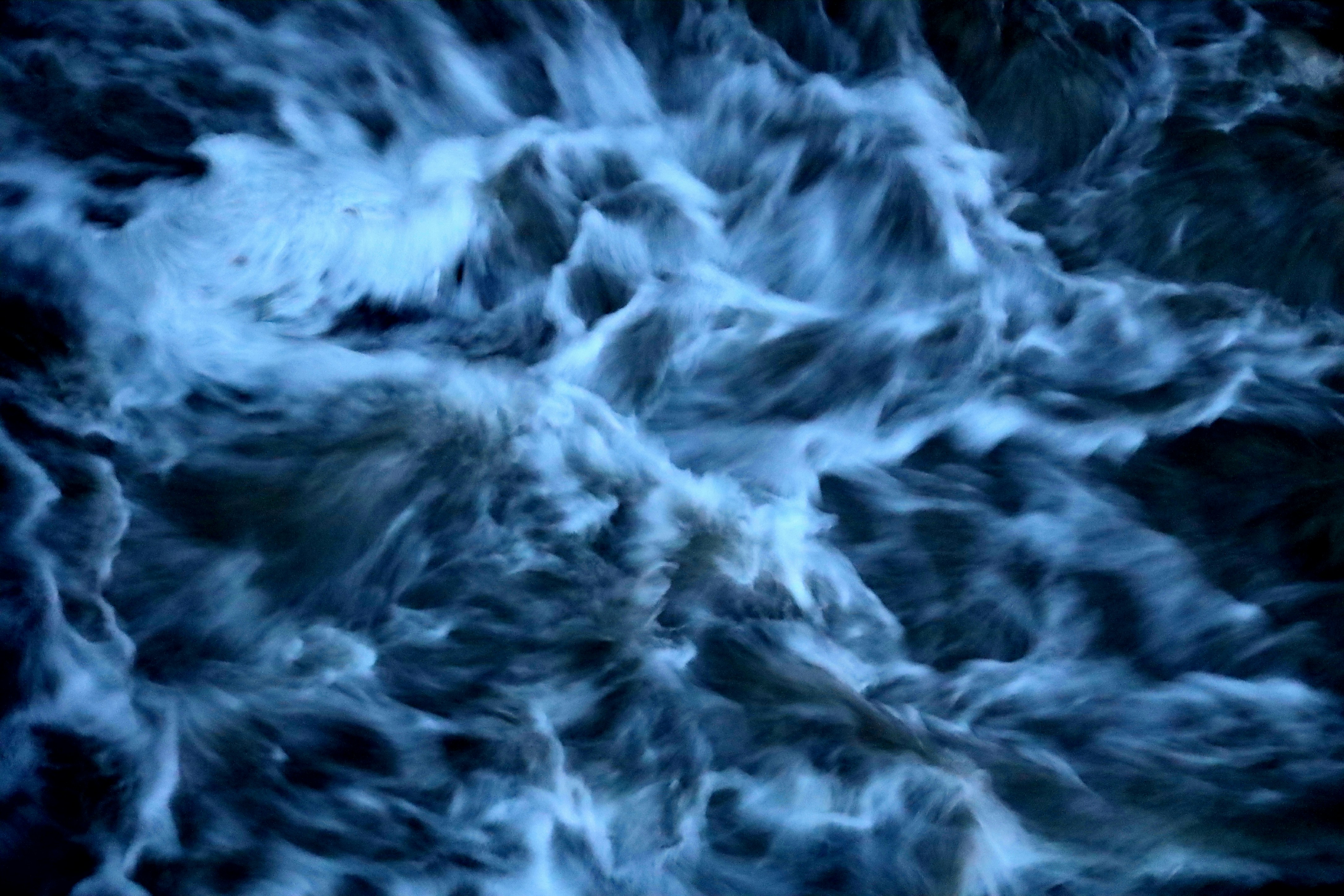 Dynamic water currents swirl and blend in a mesmerizing dance, showcasing the raw power of nature's flow.