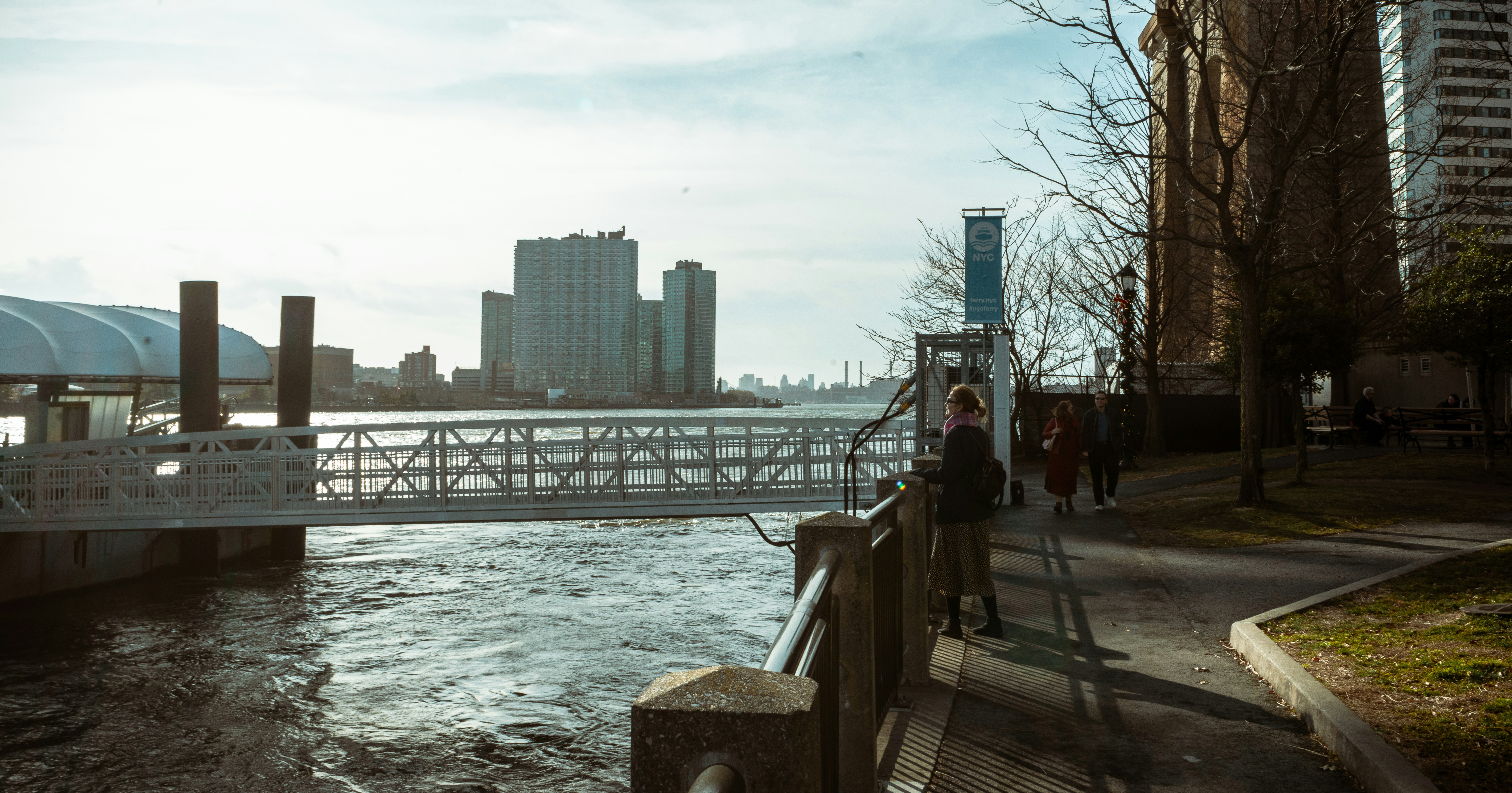 Woman standing on a railing looking over an iron bridge photo – Free ...