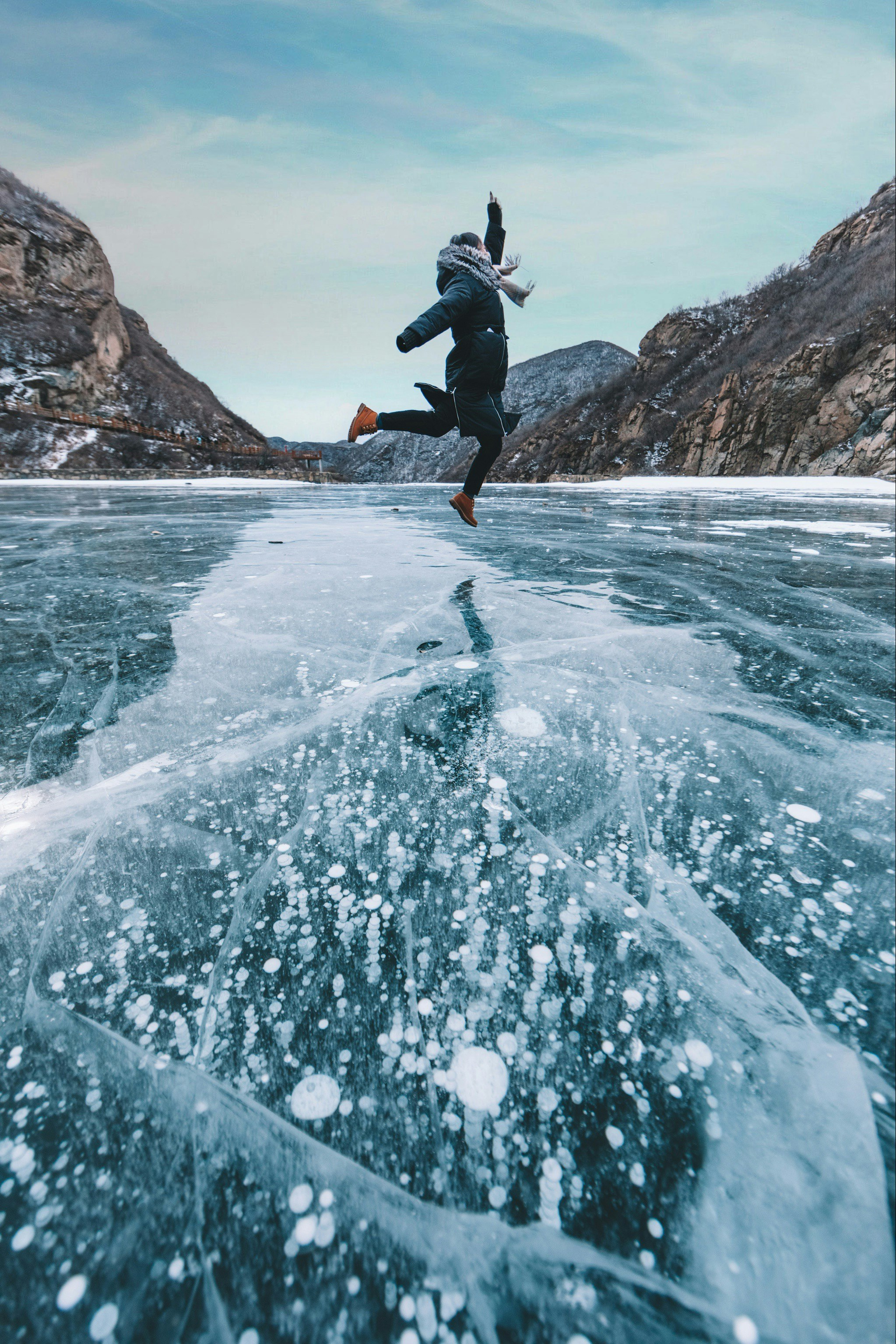 Glacial Leap: A Freestyle Jump Across a Quiet Frozen Lake