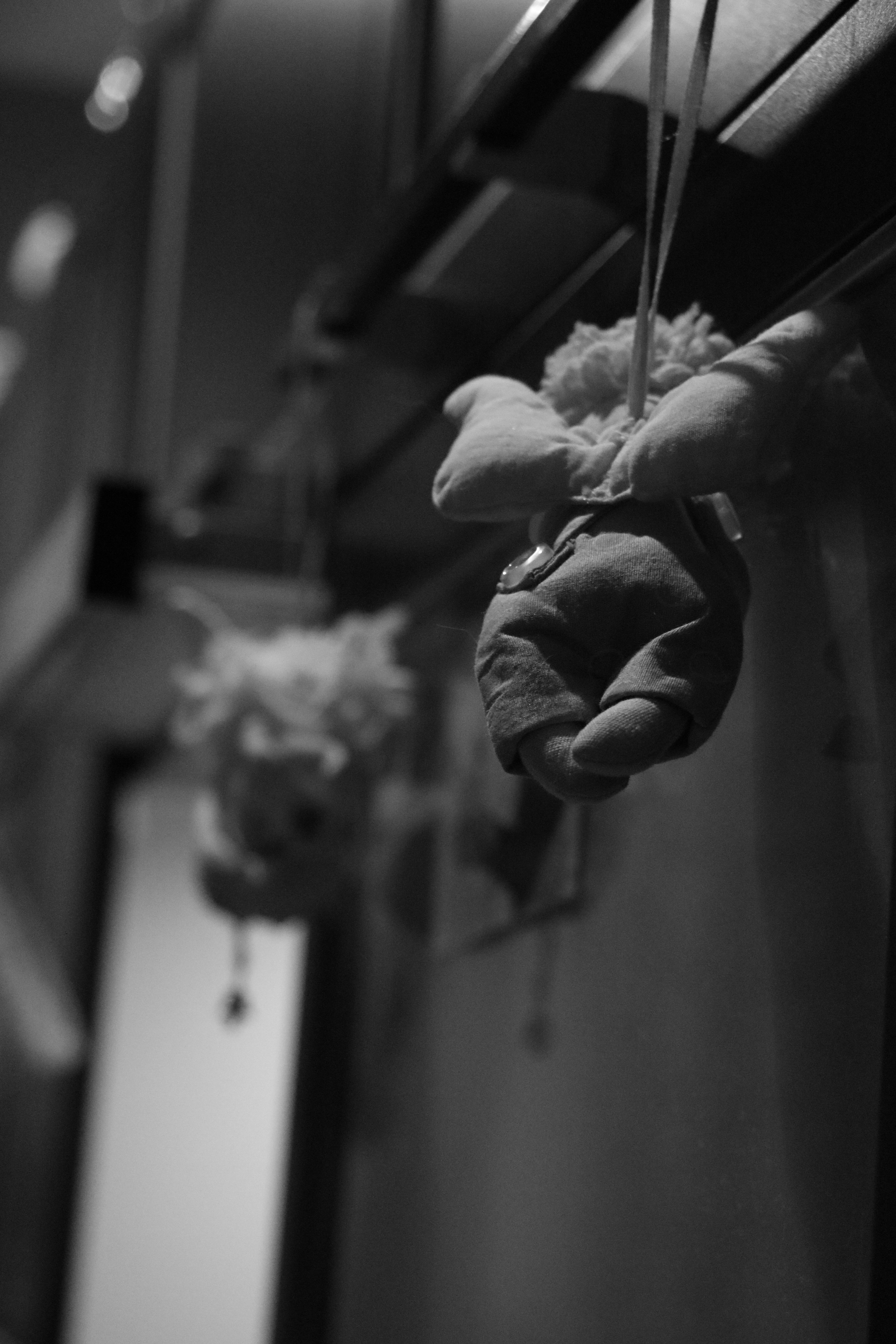 a stuffed animal hanging from the side of a wall