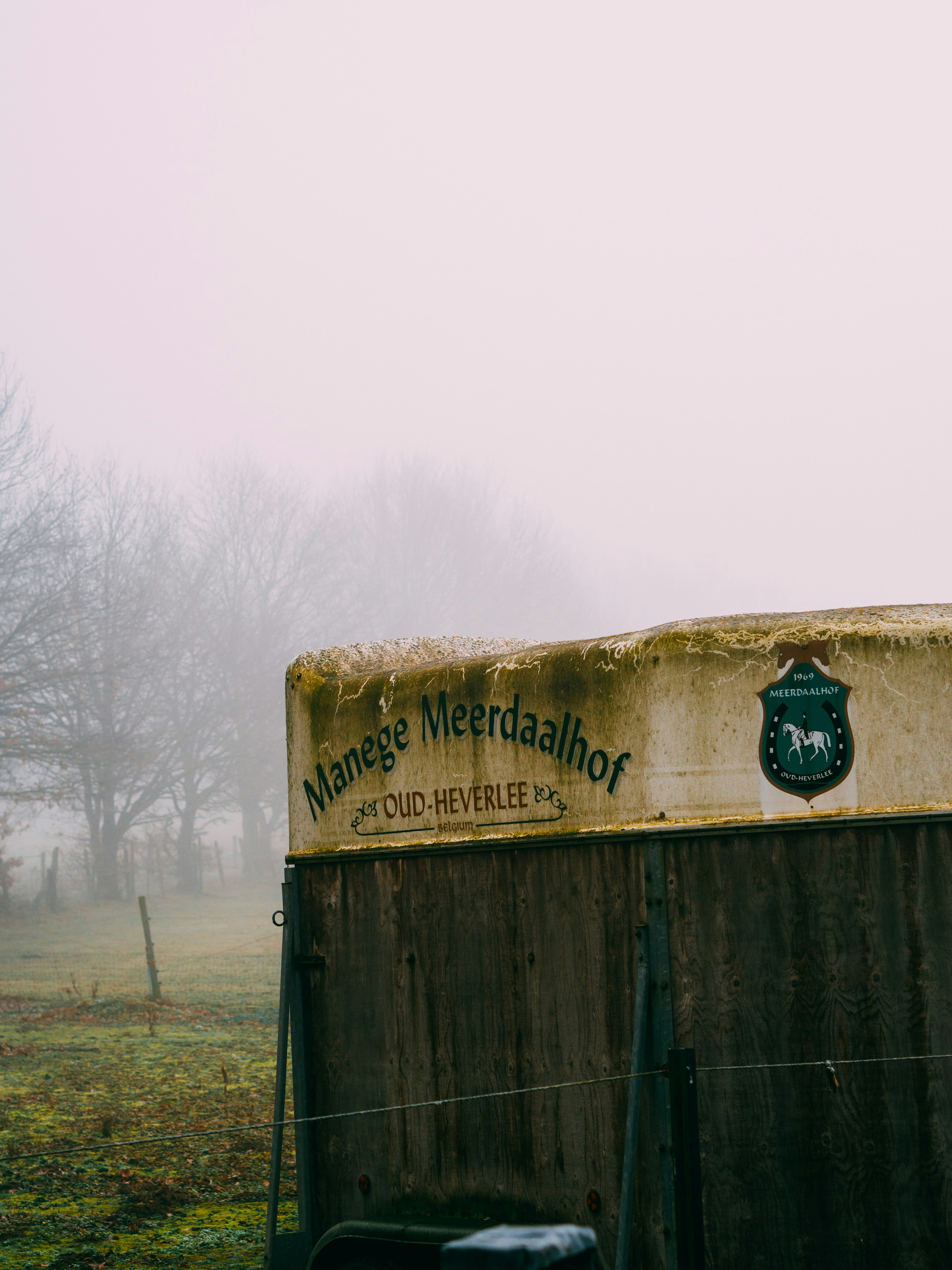 Fog over a Weathered Riding-Club Sign on a Trailer