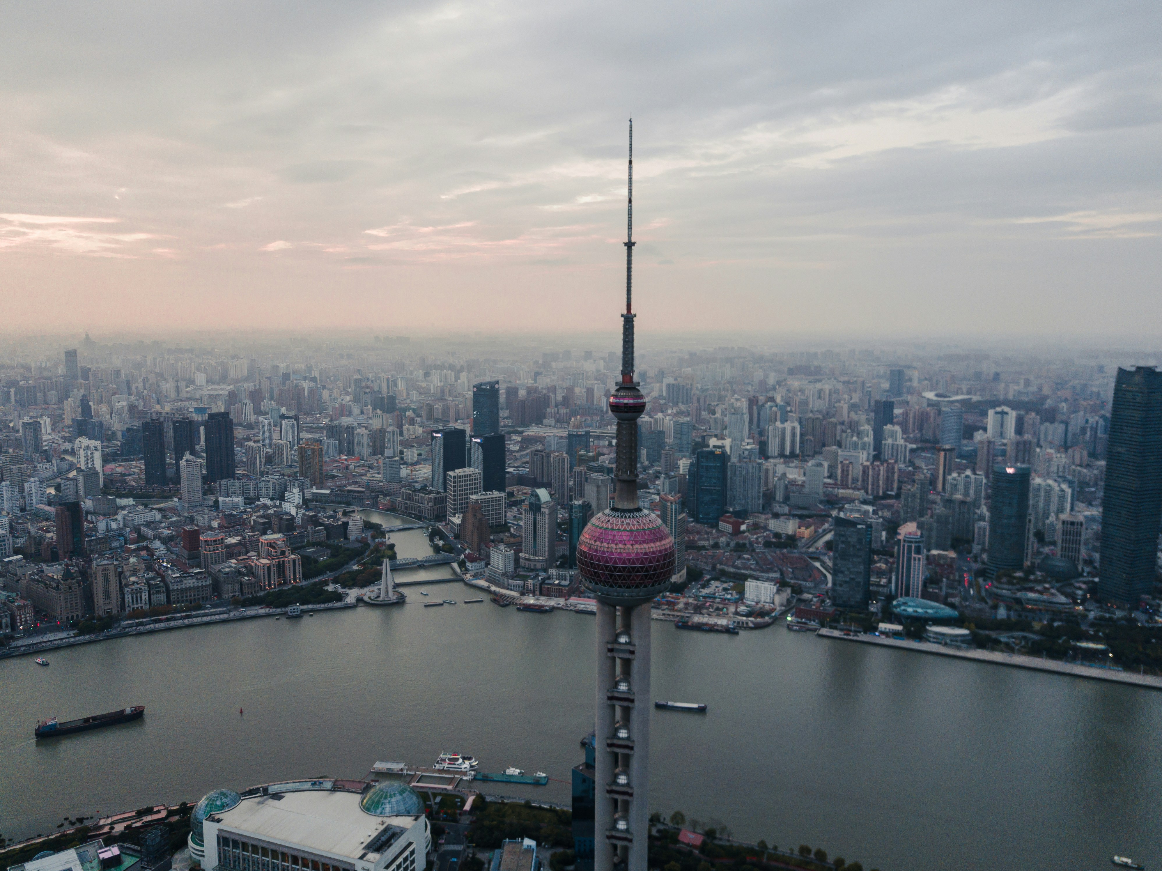 Dusk Over Shanghai: The Pearl Tower Standing Above the Silky Huangpu