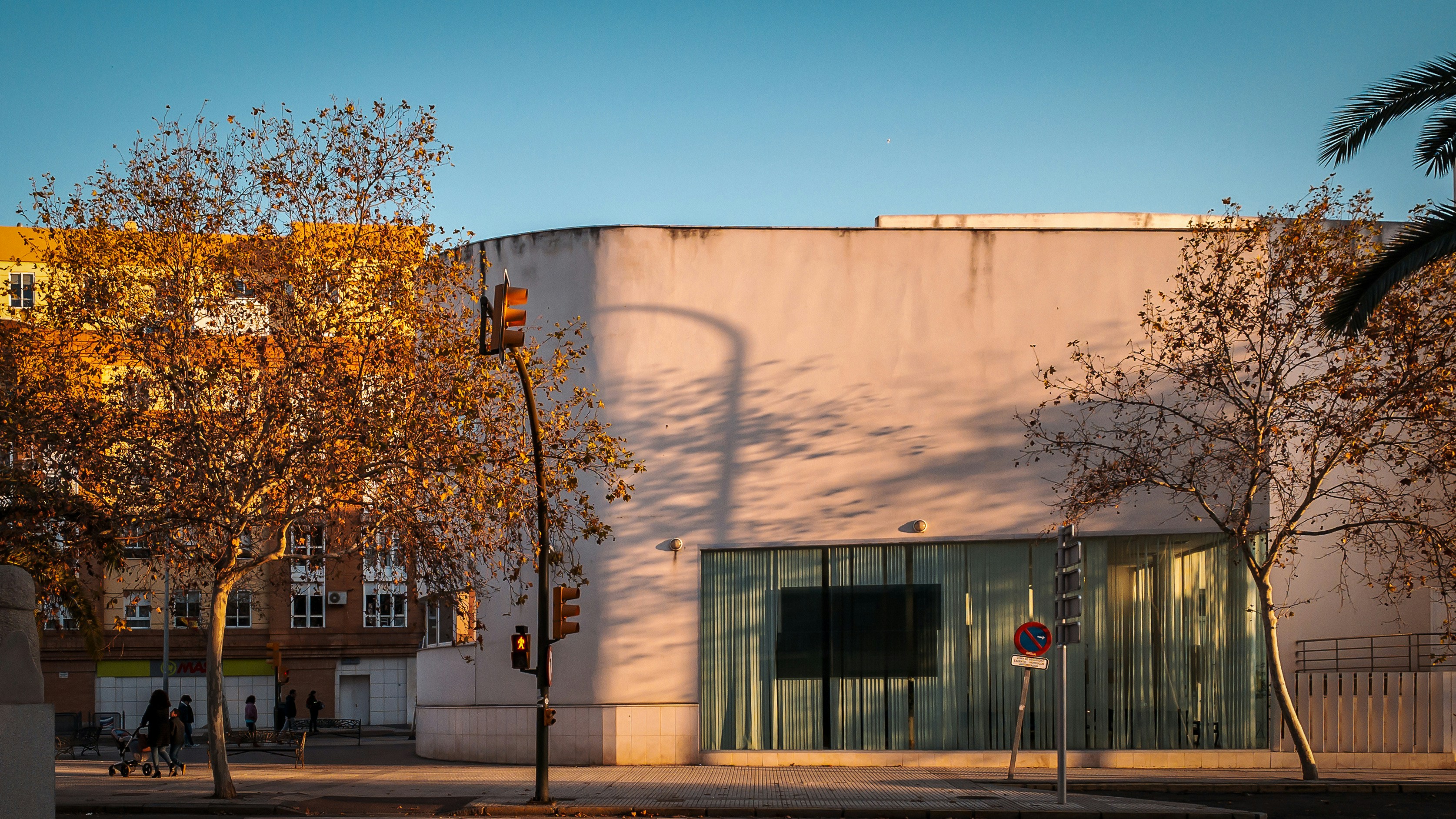 Modern building facade with geometric lines and soft evening shadows.