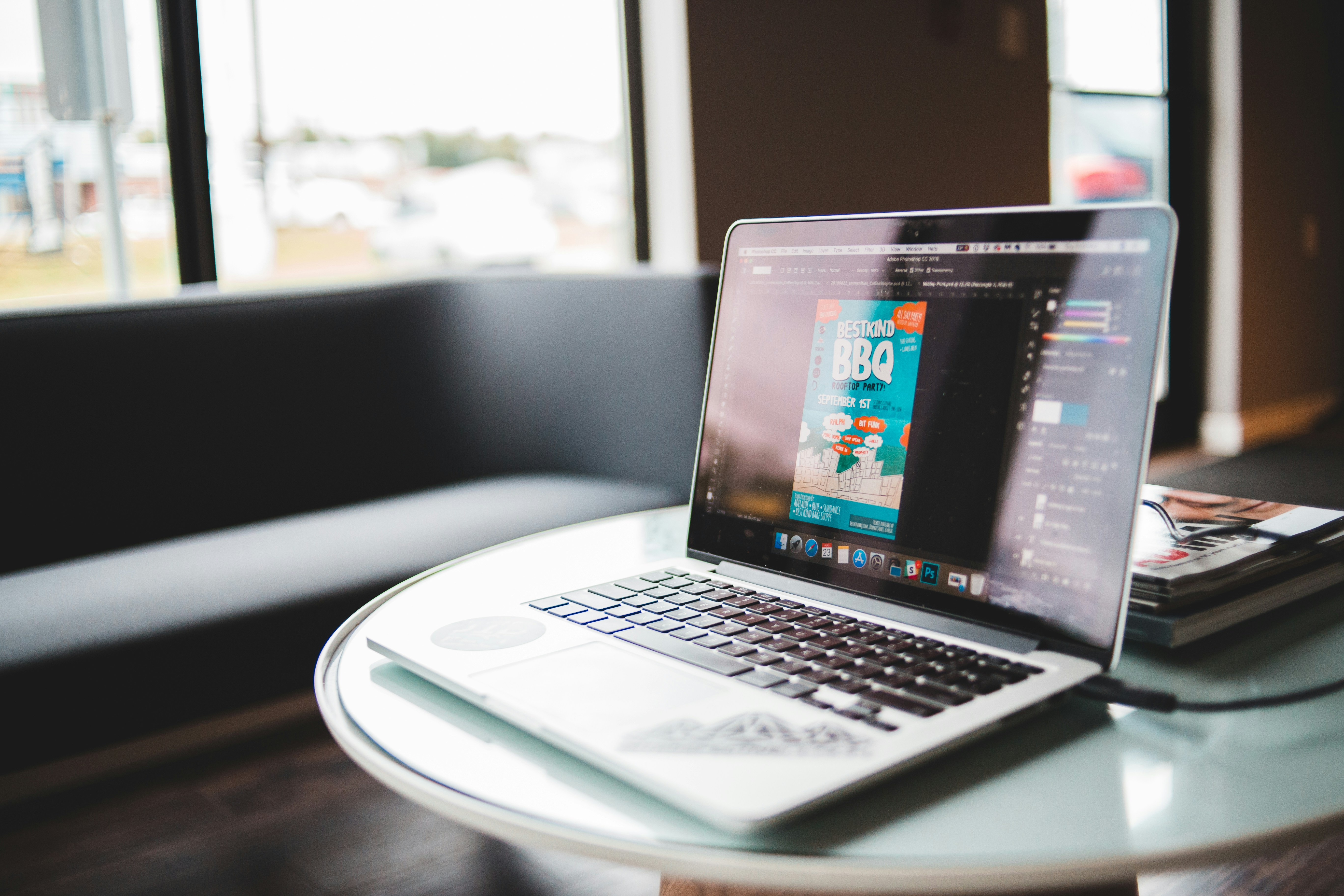 MacBook Pro near books on round white table photo – Free Computer Image ...