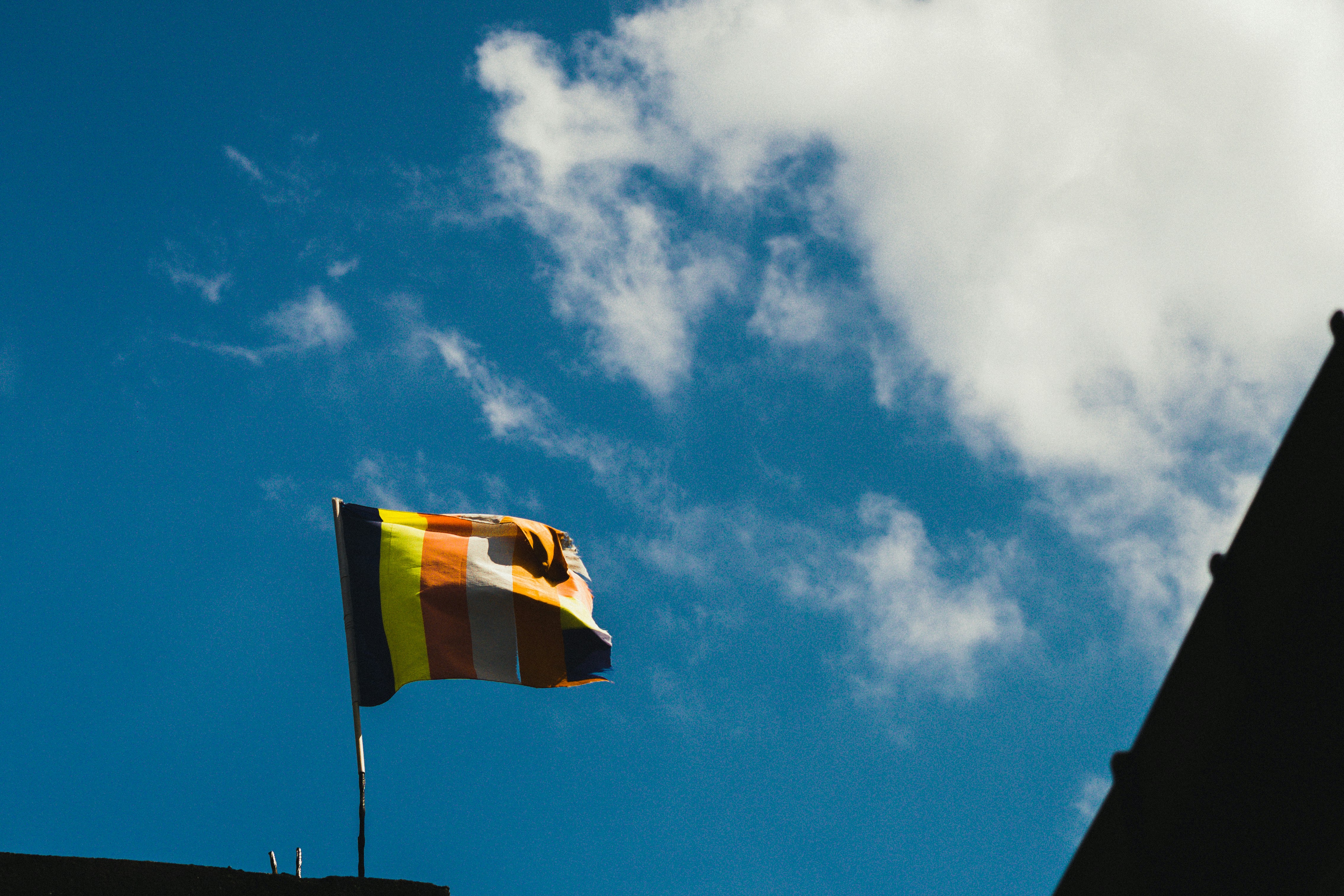Flag of Color on a Rooftop: A Quiet Sky Contrast