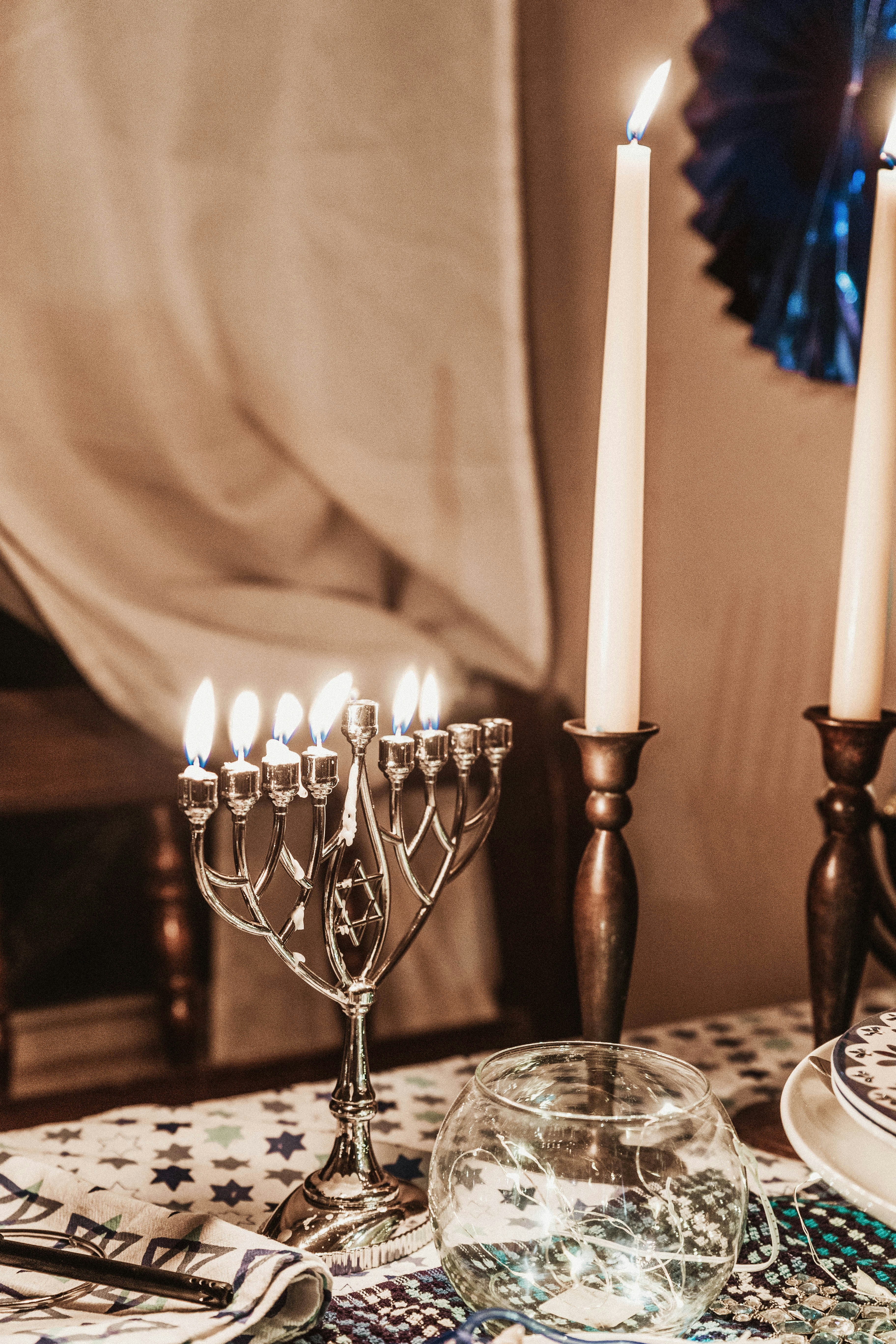 Candlelit Hanukkah Table with Menorah and Glass Bowl