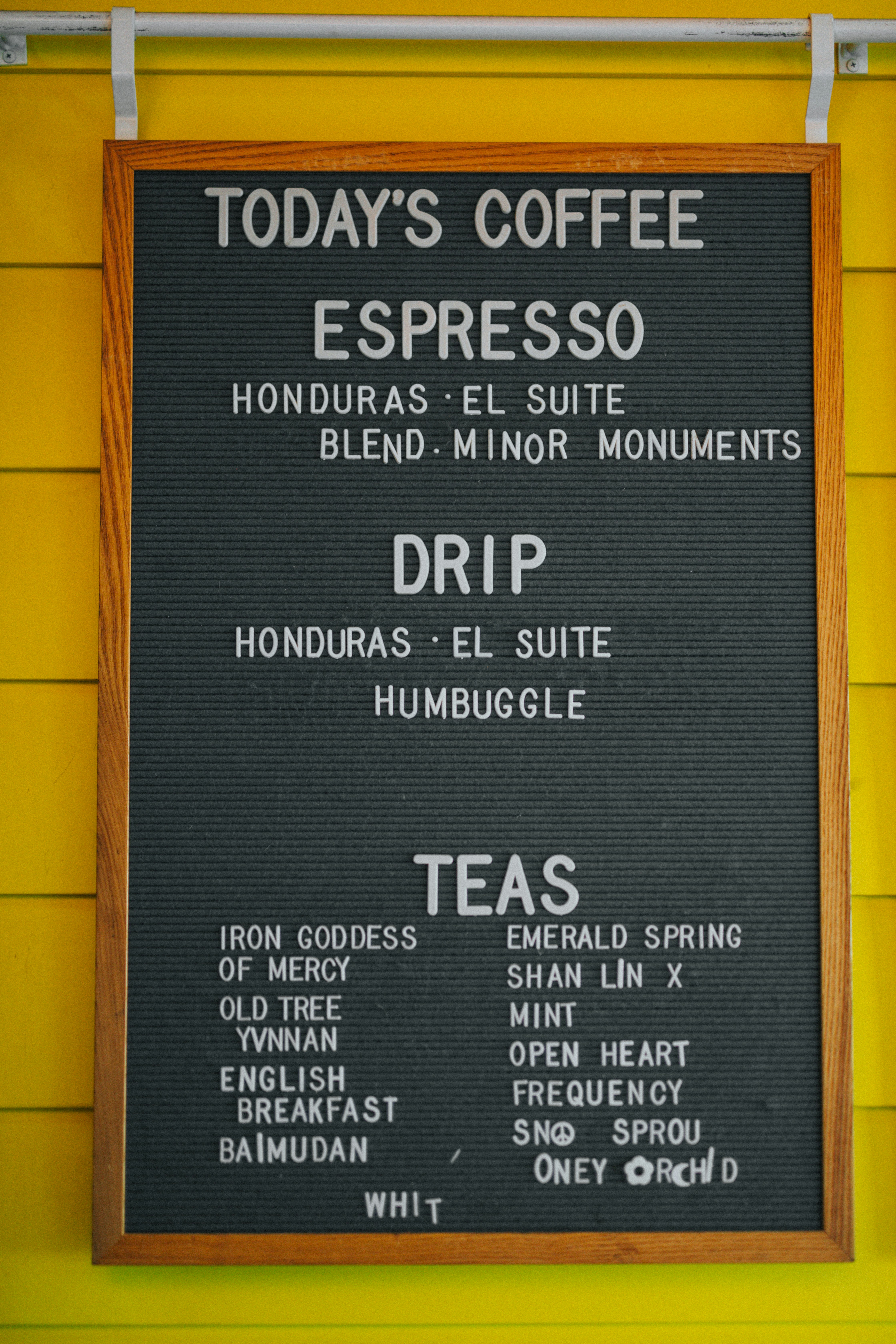 A chalkboard menu displaying today's coffee and tea offerings in a cozy café setting.