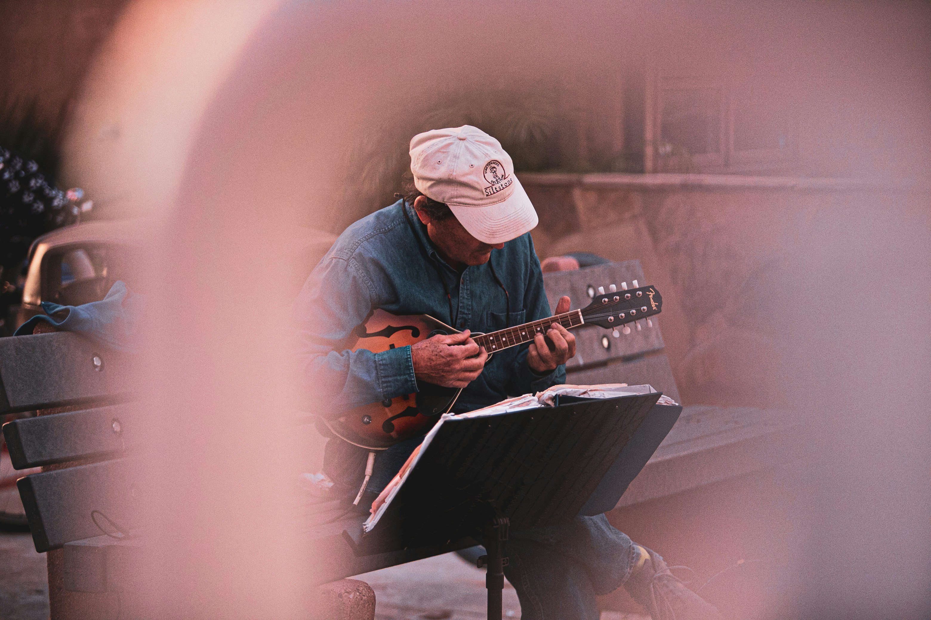 Through a Rosy Ring: A City Street Musician Plays an Acoustic Guitar