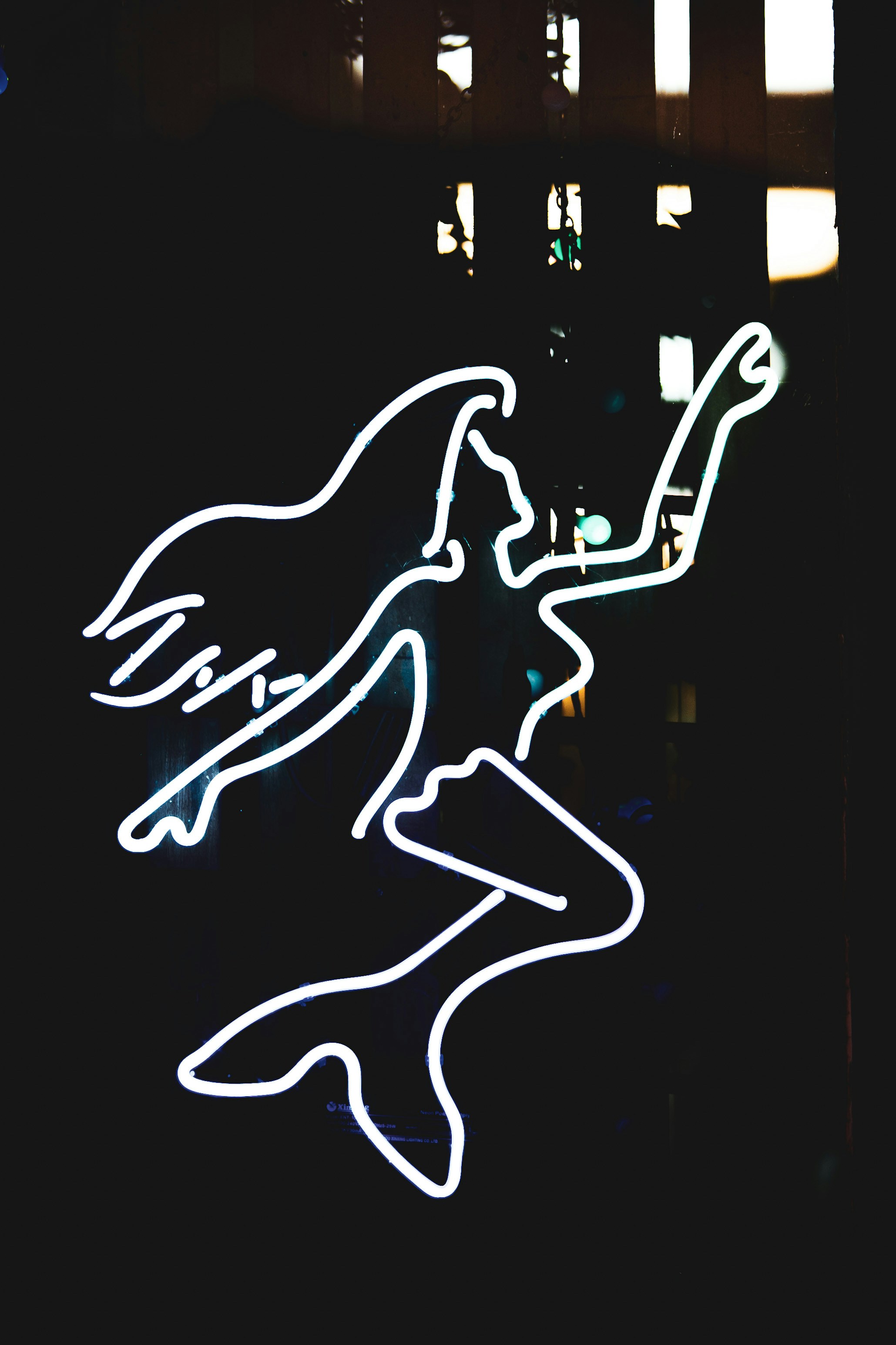 Neon Angel in Flight over a Dark Cityscape