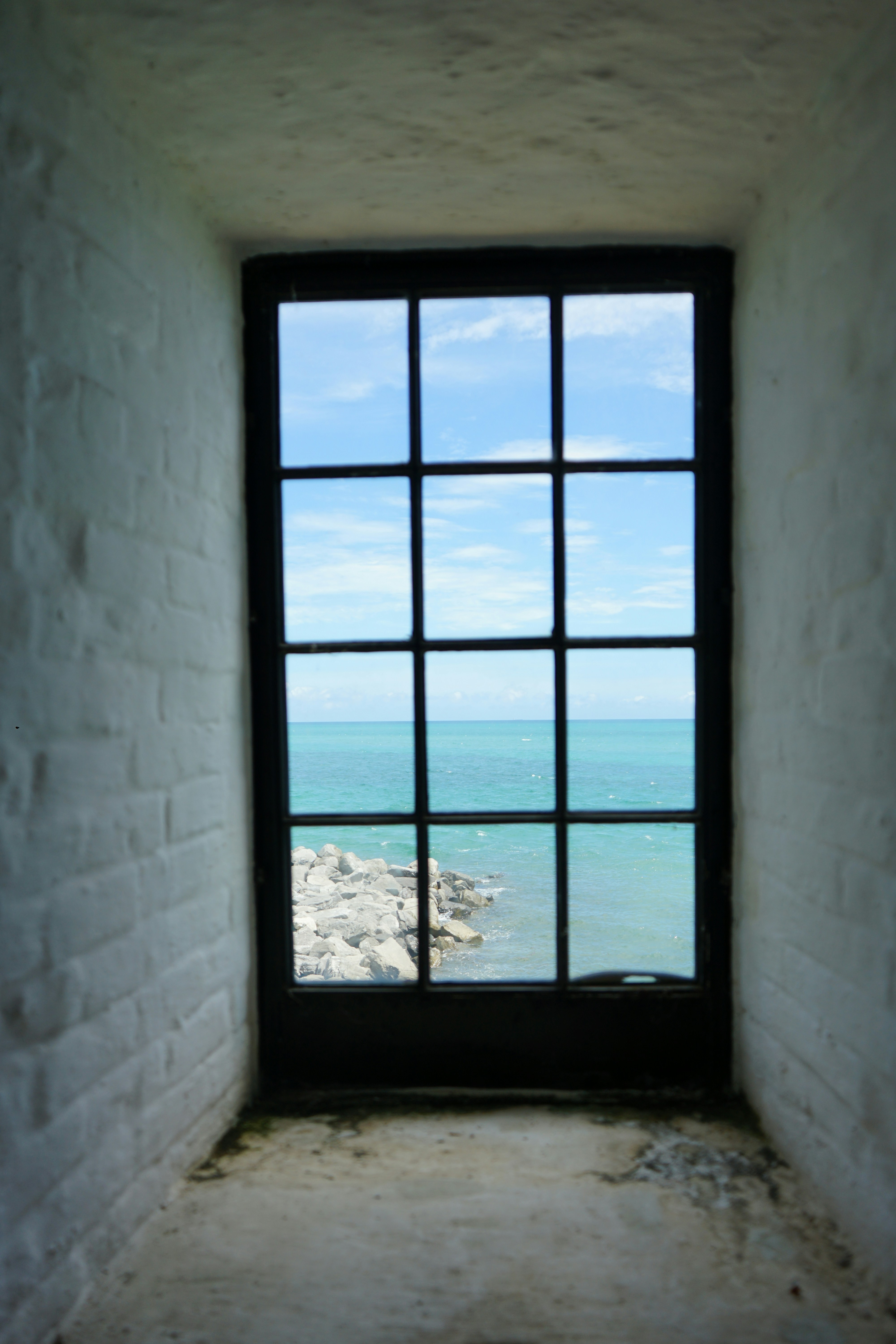 Horizon Framed by Bricked Walls: Sea View Through a Grid