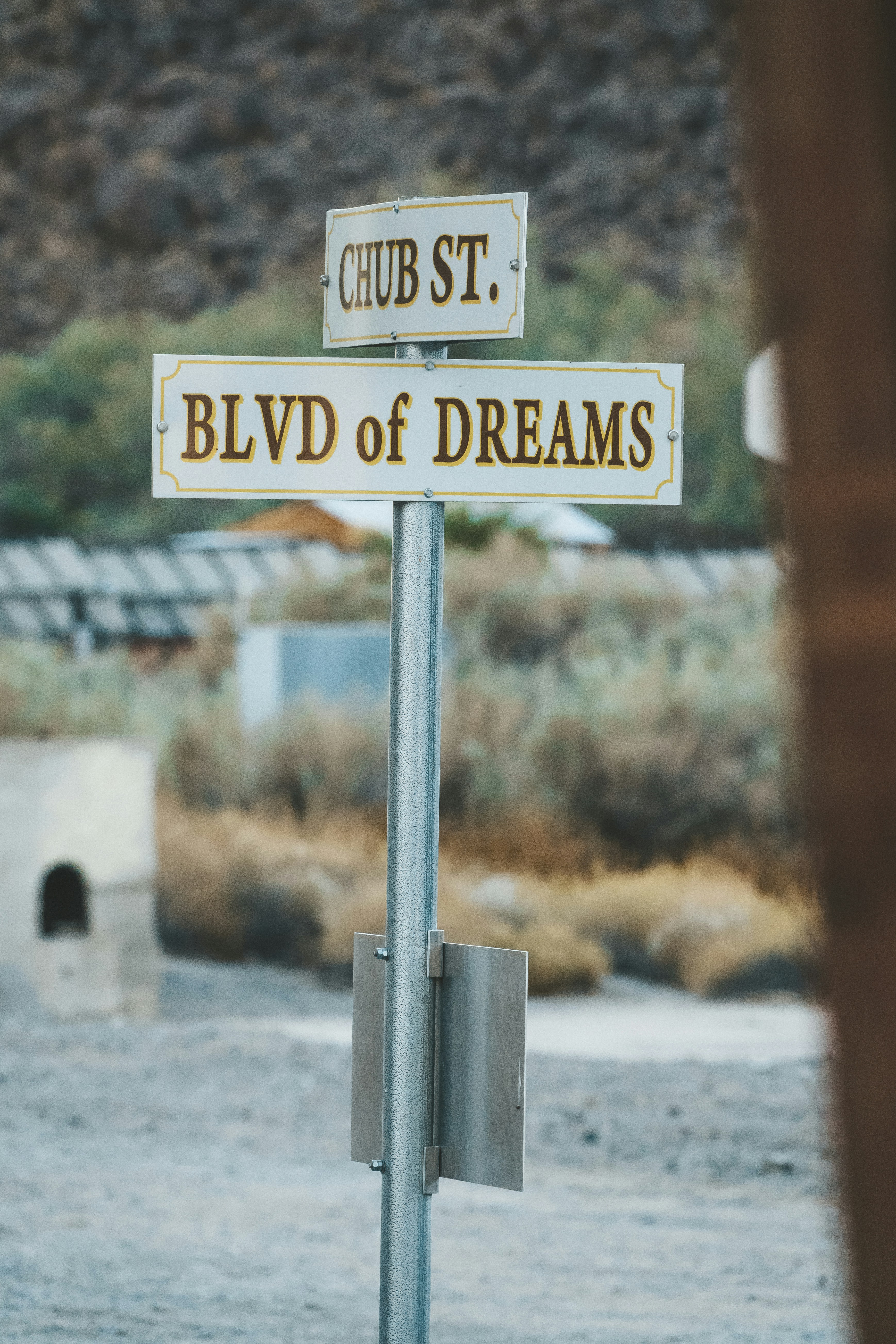 Street sign indicating the intersection of Chub St. and Blvd of Dreams, set against a natural backdrop.