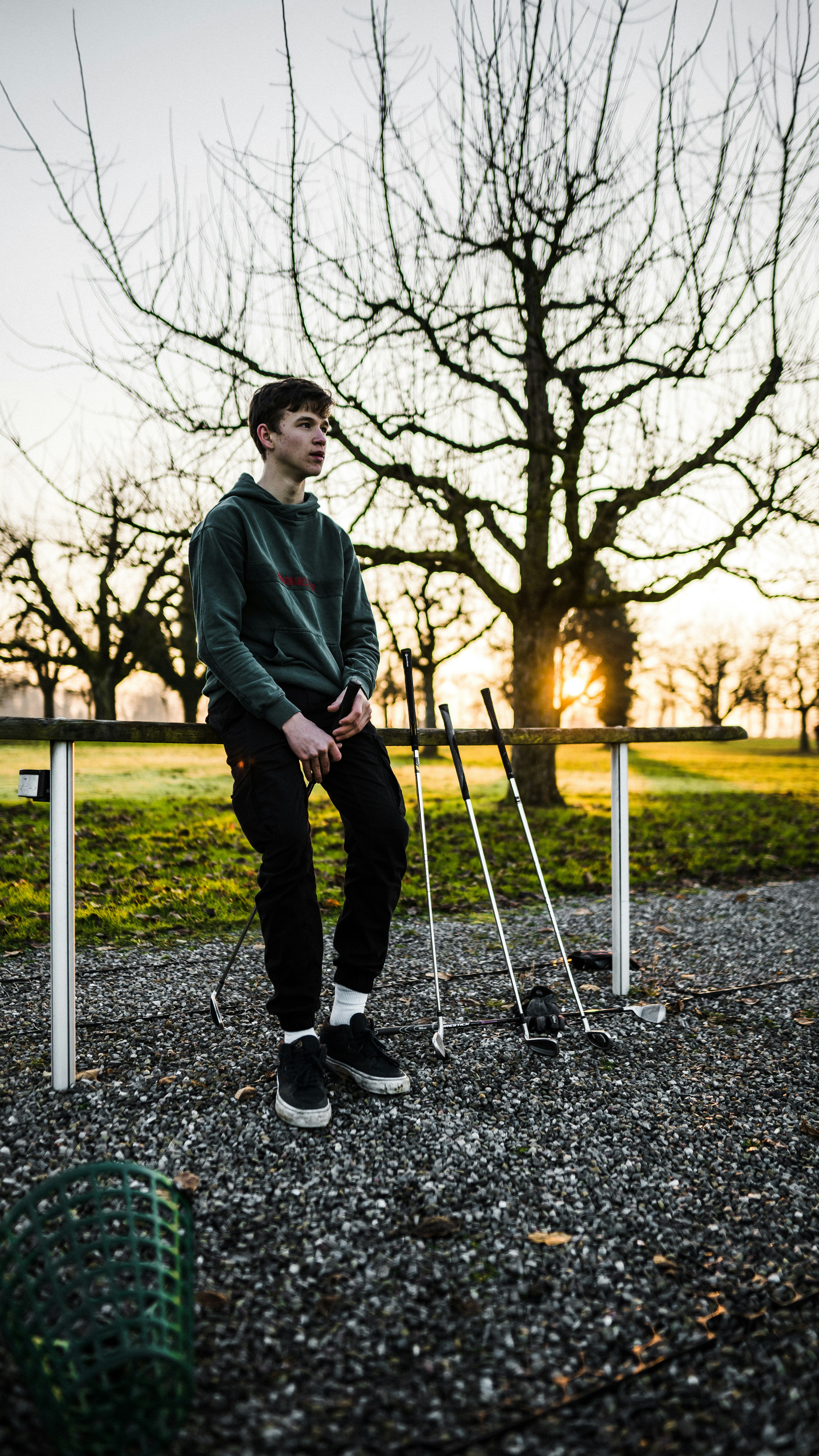Man standing beside railing and golf clubs photo – Free Human Image on ...