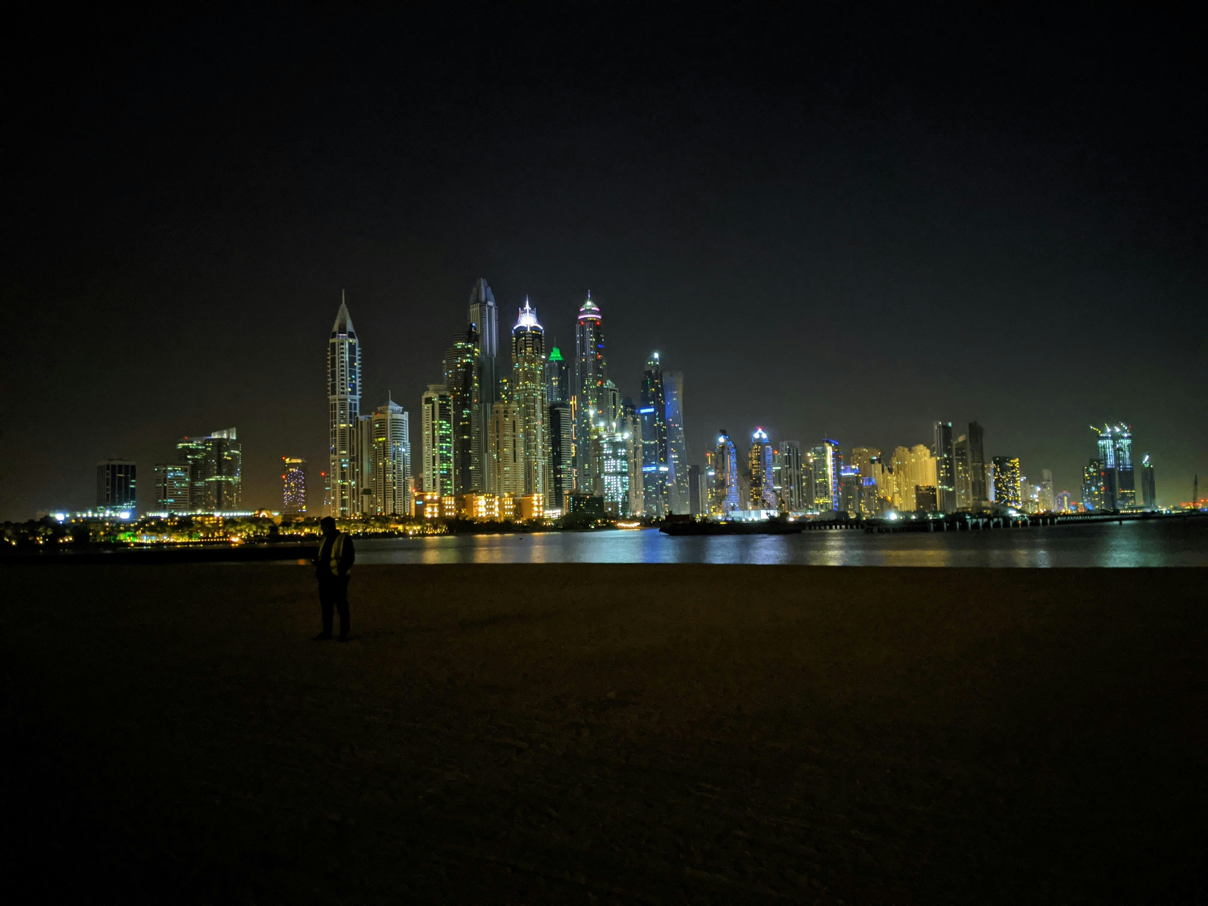 Nocturnal Skyline Reflections from a Quiet Shore