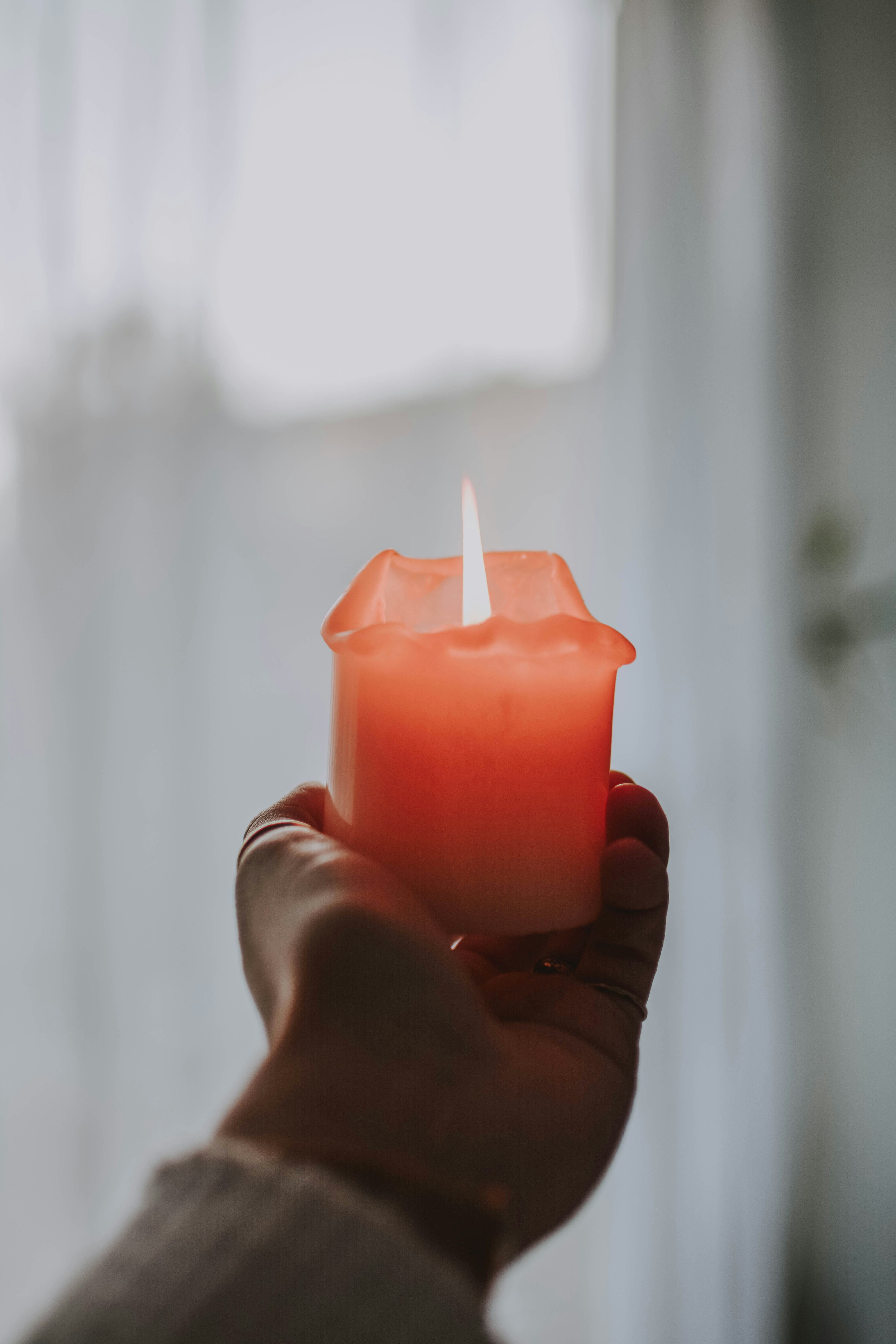 Person holding pink lighted candle photo – Free Candle Image on Unsplash