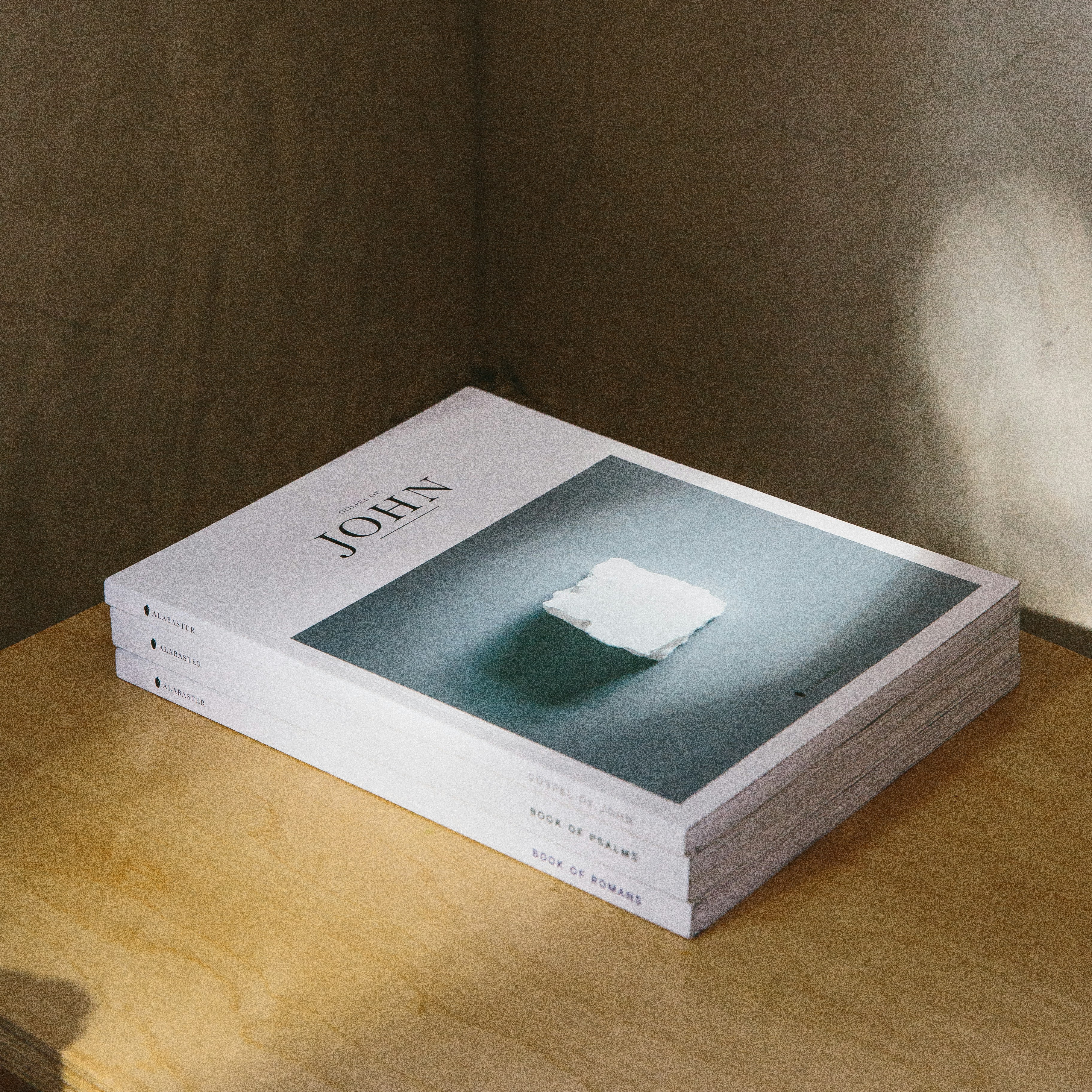 JOHN Volumes on Maple: A Minimal Still Life in Gentle Light