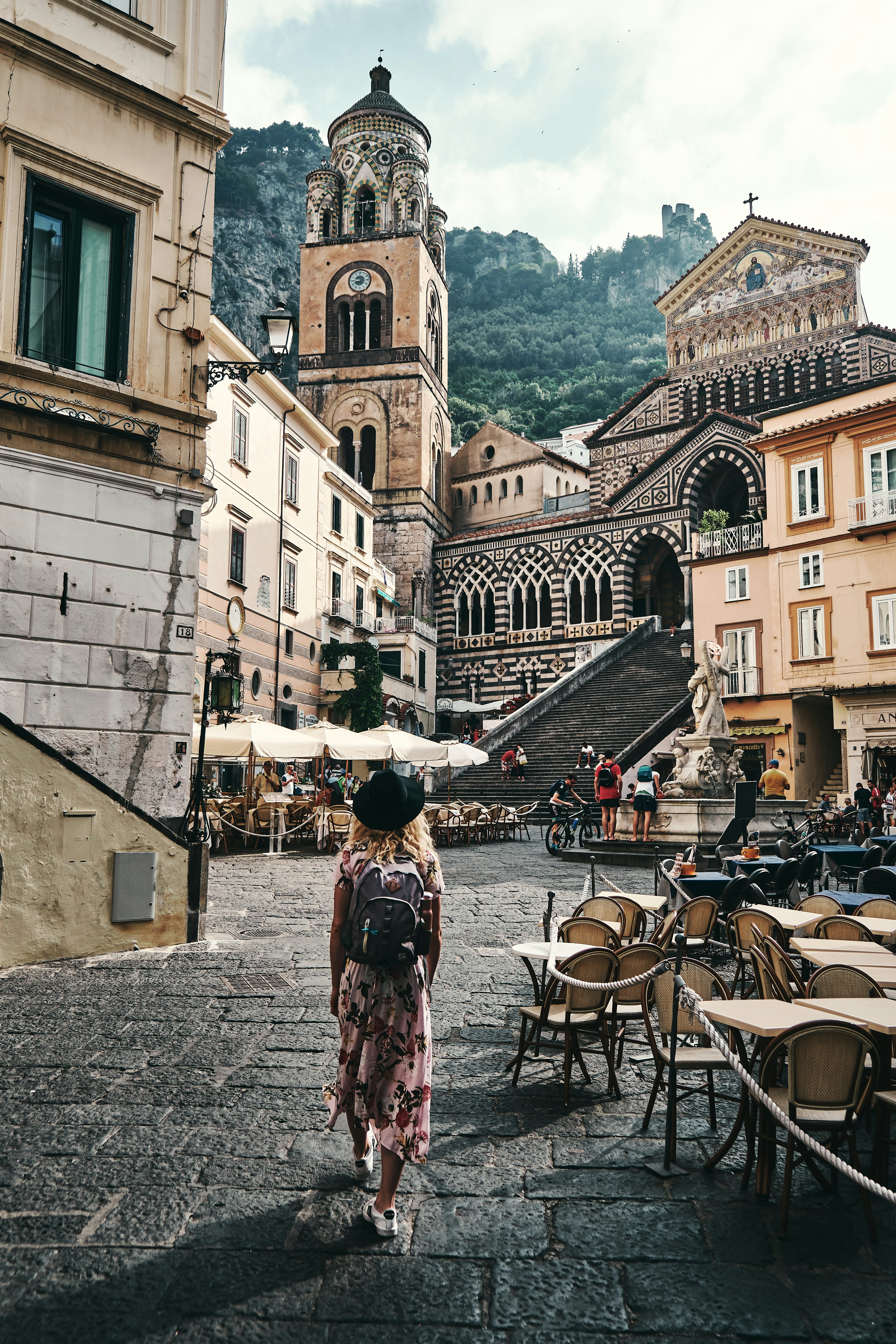 Steps Toward the Striped Cathedral: A Backpacker in a Sunlit European Piazza