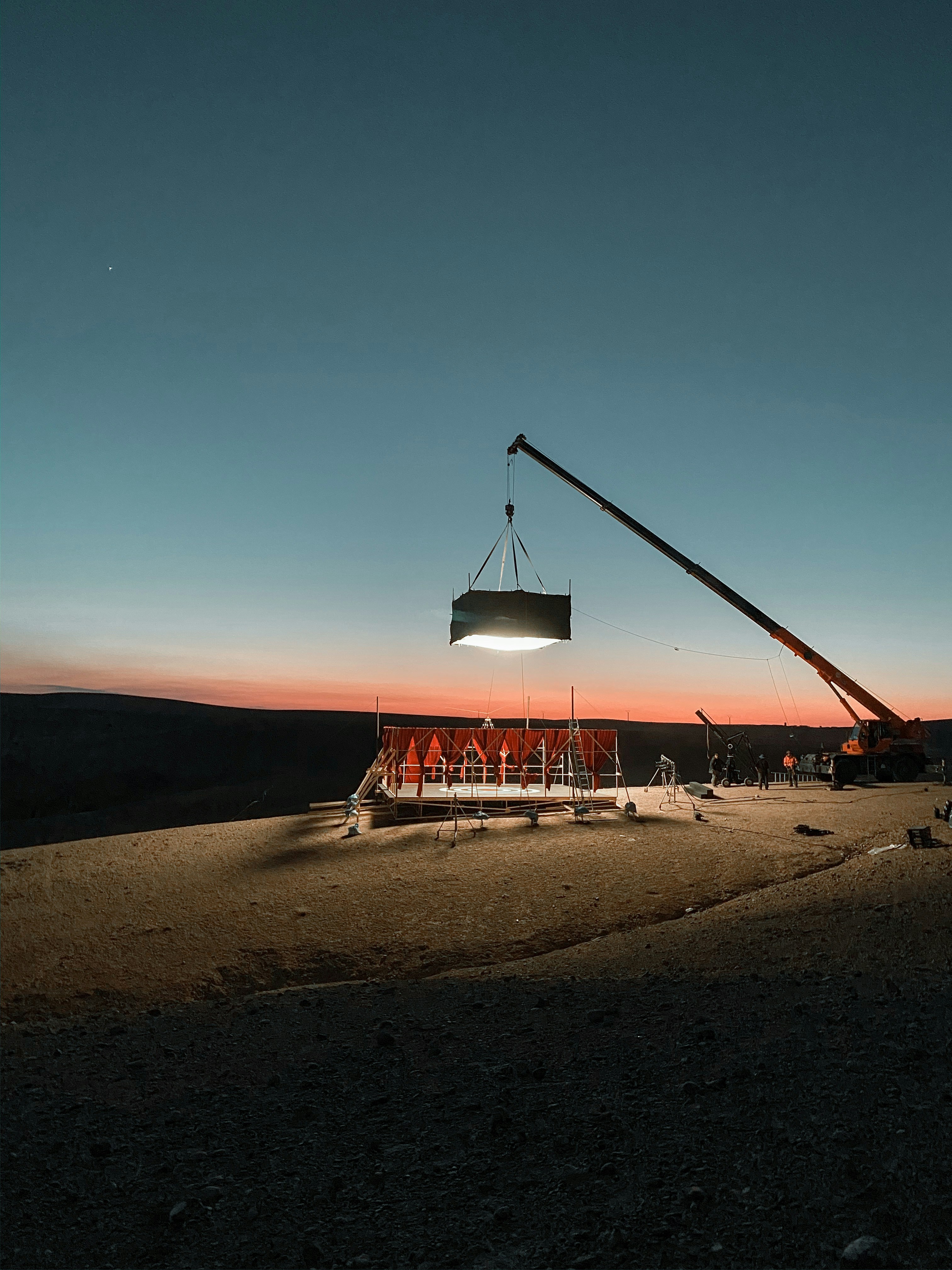 Crane Snow-Glow: Night Site Lift Over Desert Rim