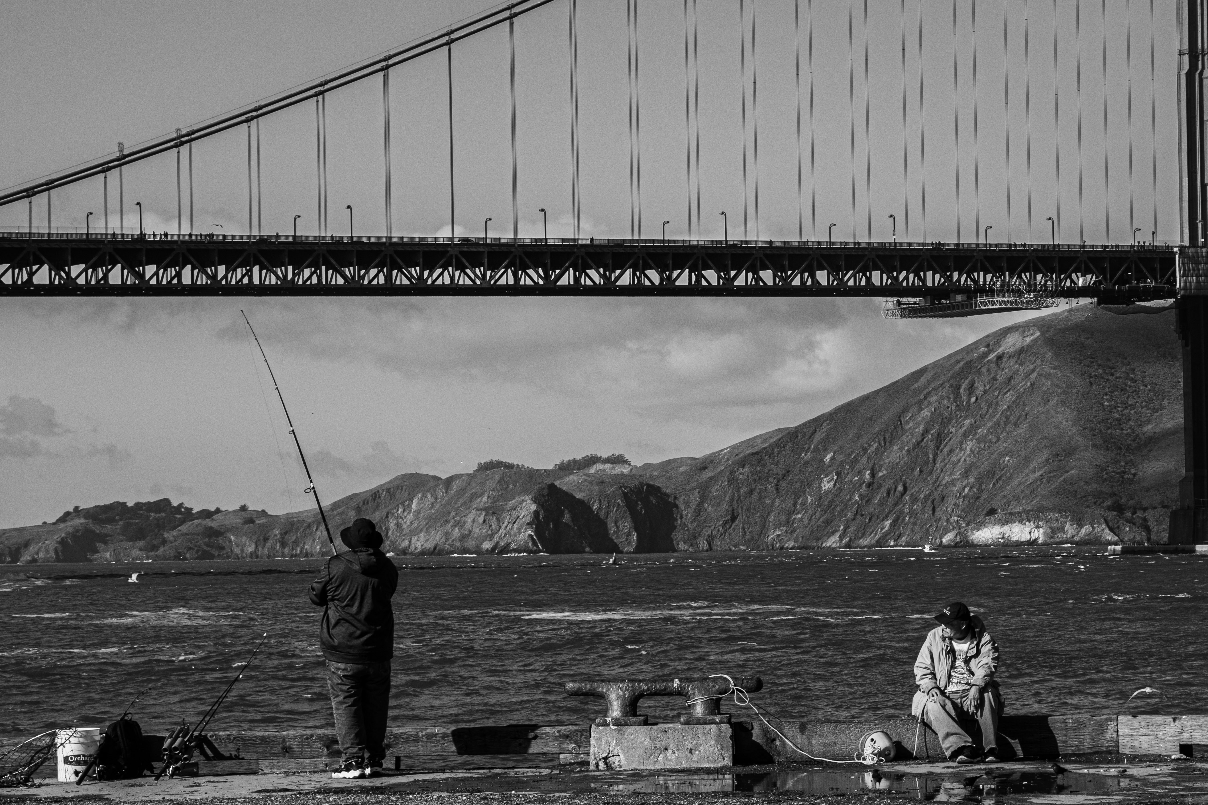 Fishing on the Fractured Shore: Lantern Light by the Bridge