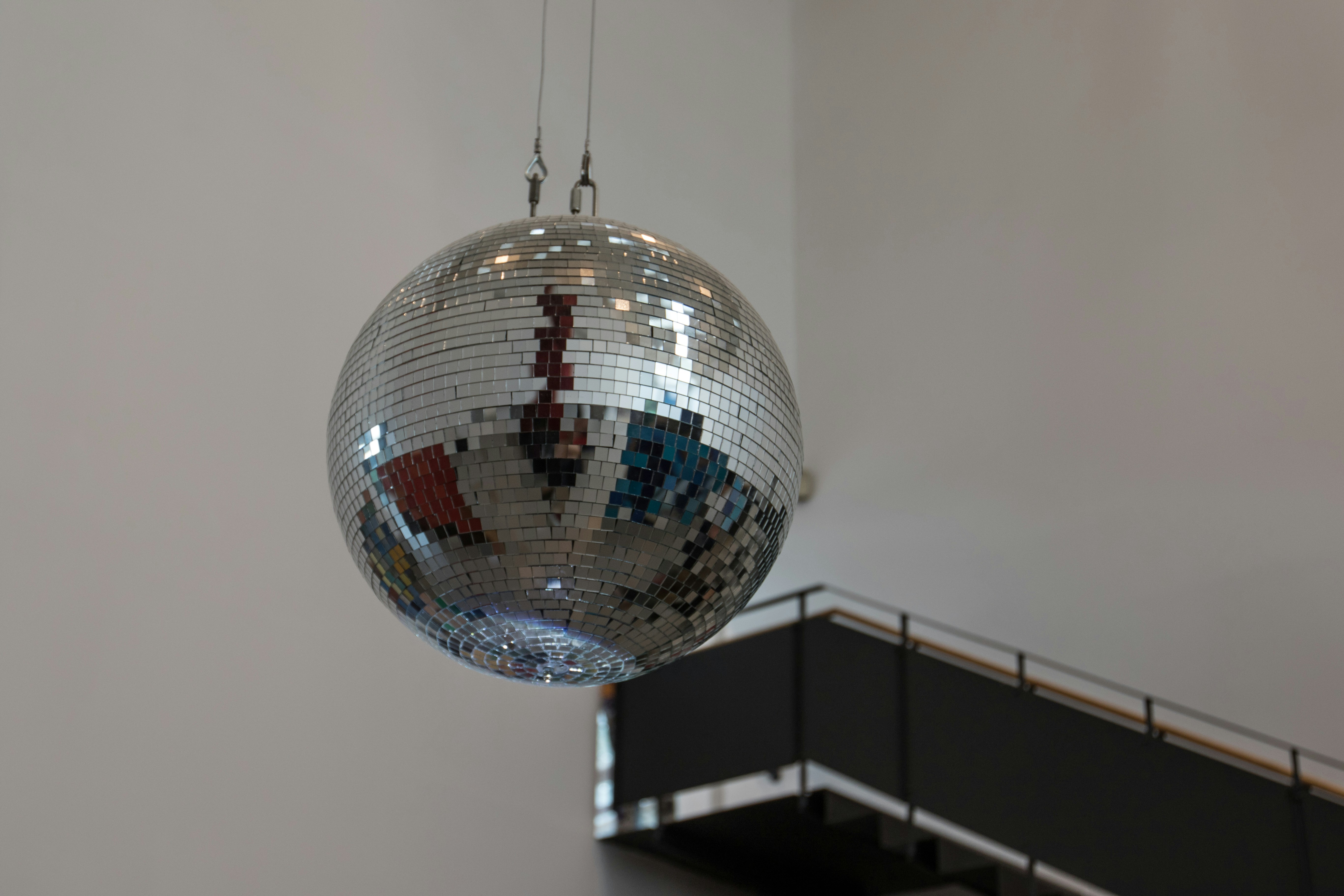 Mirrorball in a Minimal Loft: Reflections Along a Quiet Staircase