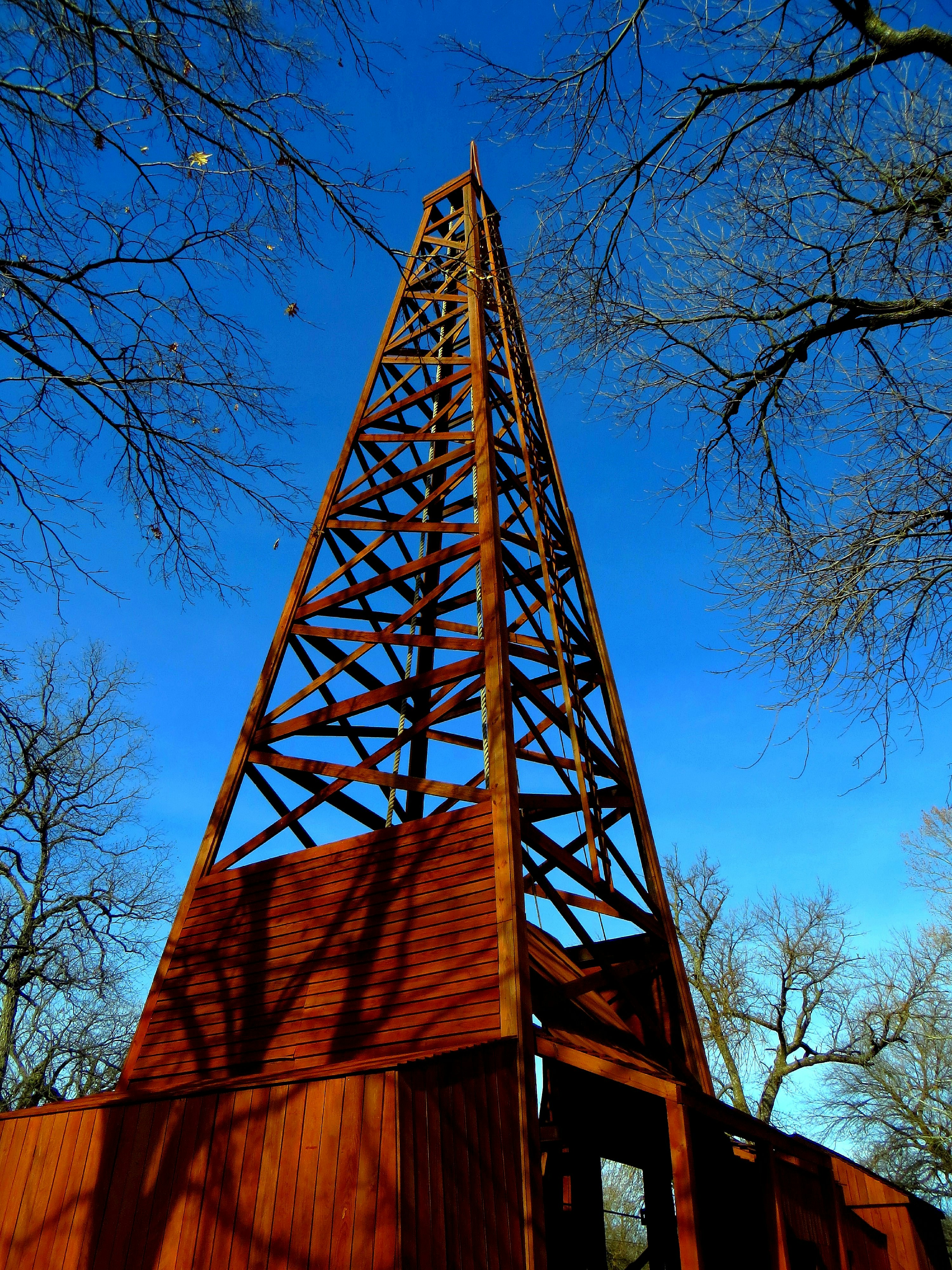 Rising Rust: A lattice tower piercing a cobalt sky