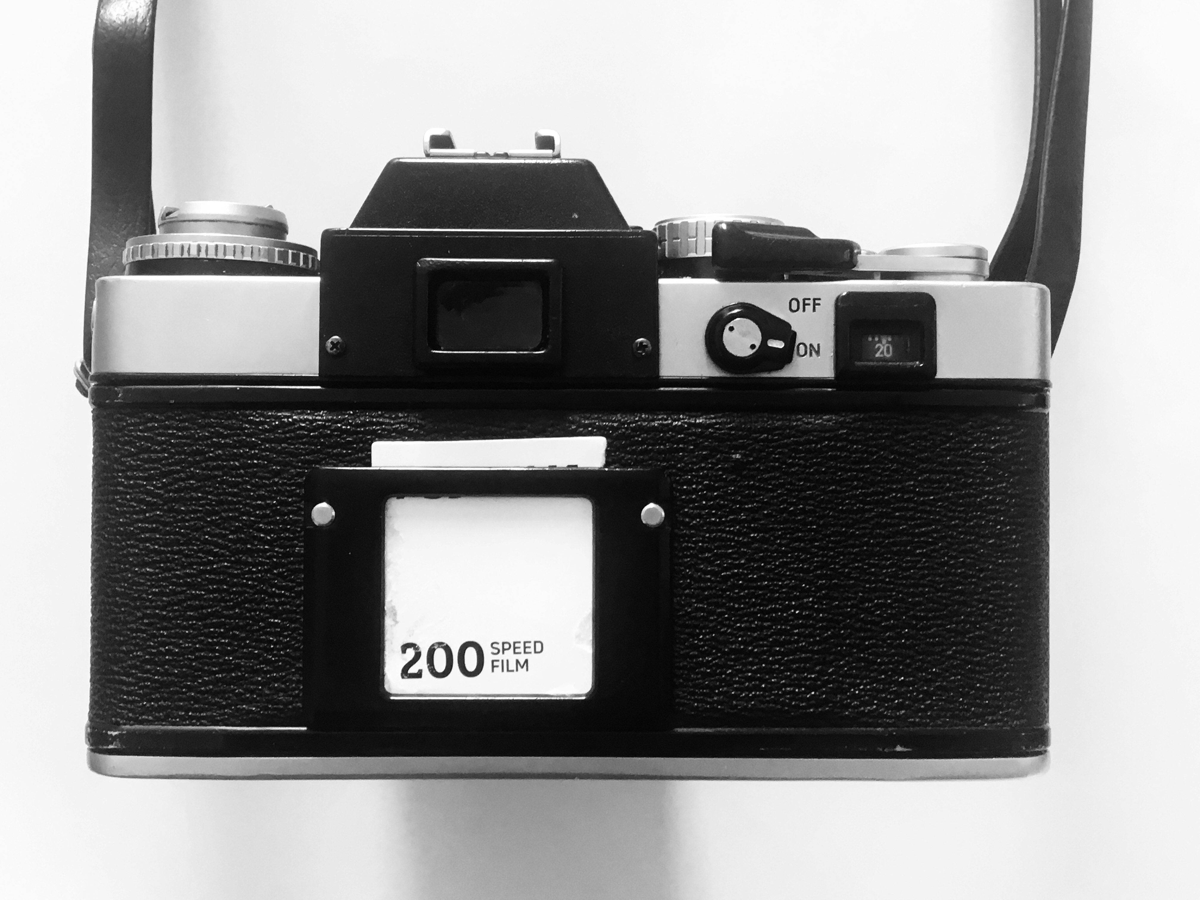 Vintage camera viewed from above, showcasing its film compartment and controls. The focus is on the film speed indicator labeled '200'.