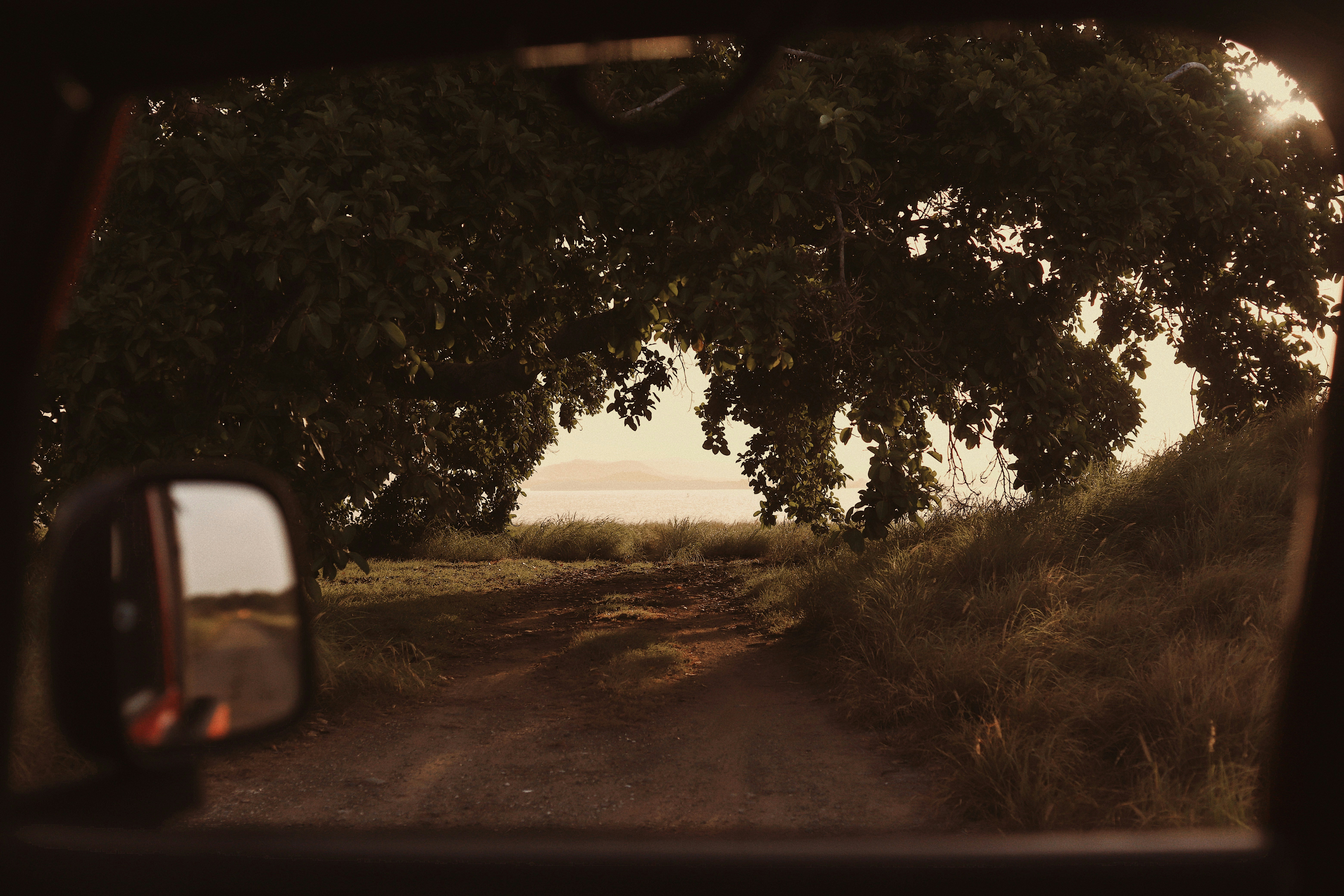 A view of a dirt road through a rear view mirror photo – Free ...
