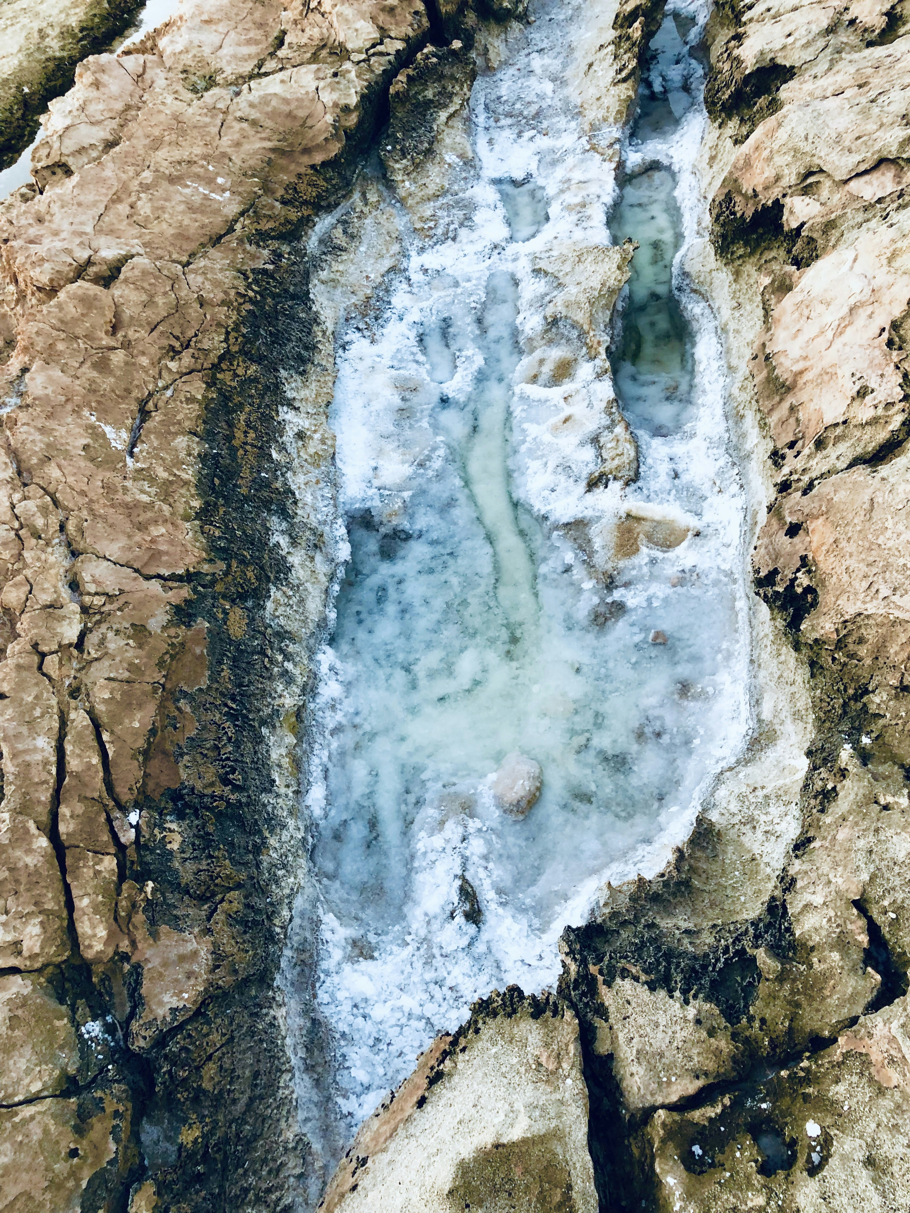 Turquoise Vein Carving Through a Rust-Colored Canyon