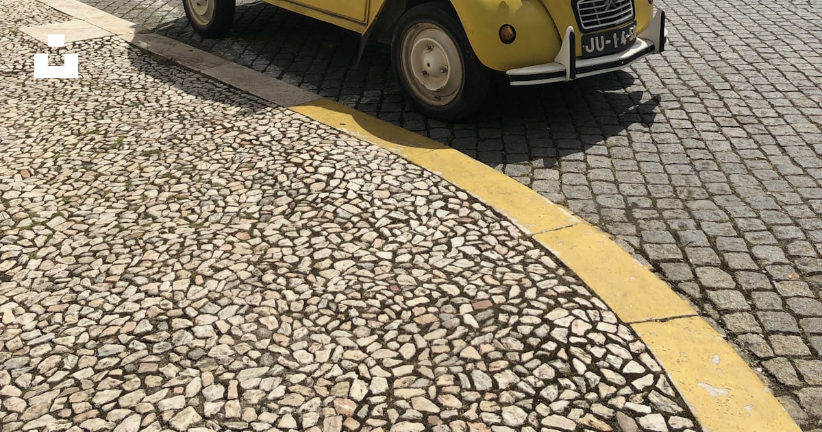 Yellow Volkswagen Beetle Parked On Side Of The Road During Daytime