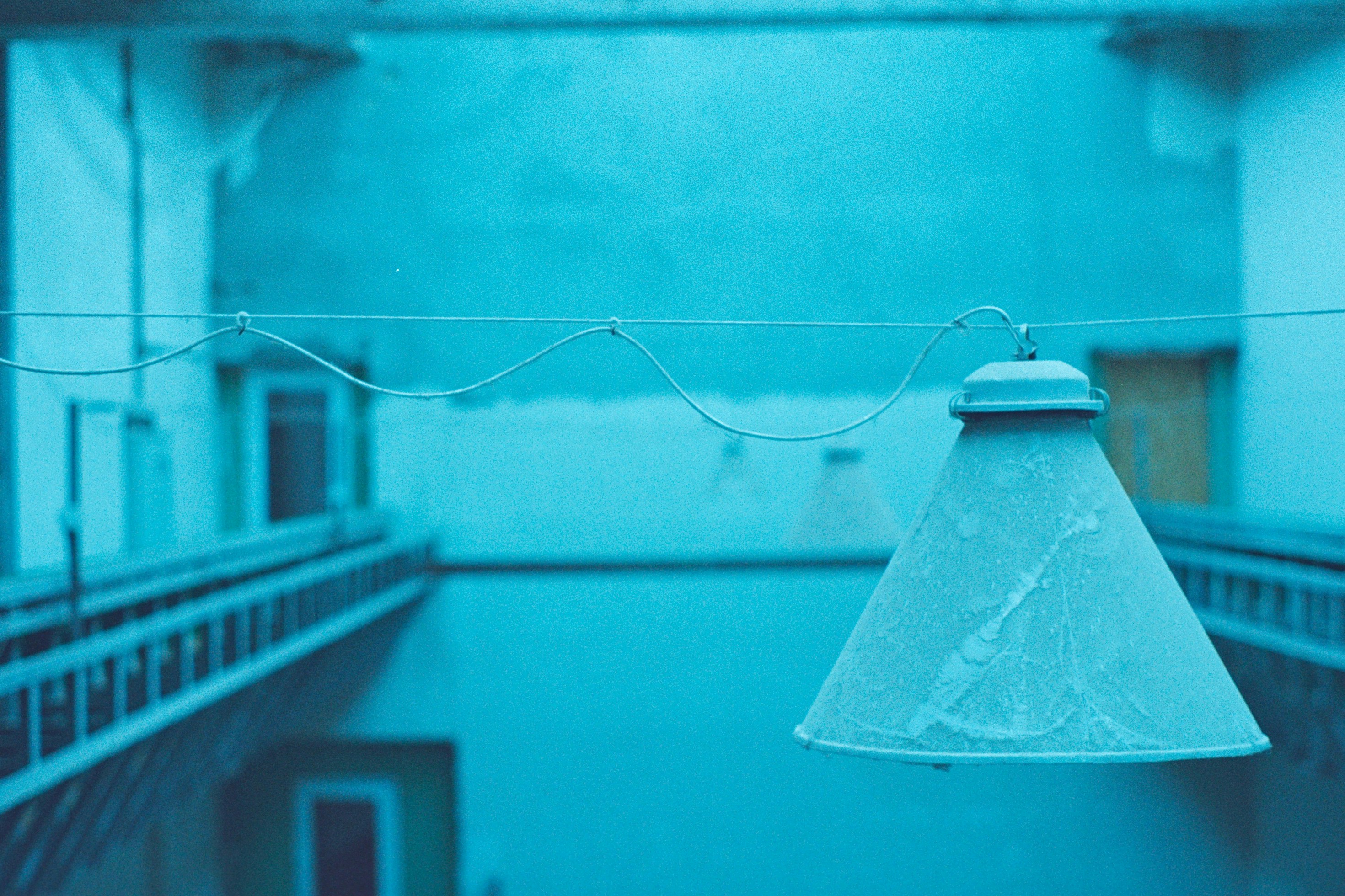 Blue Echoes: A Rooftop Pendant in Soft Gloom