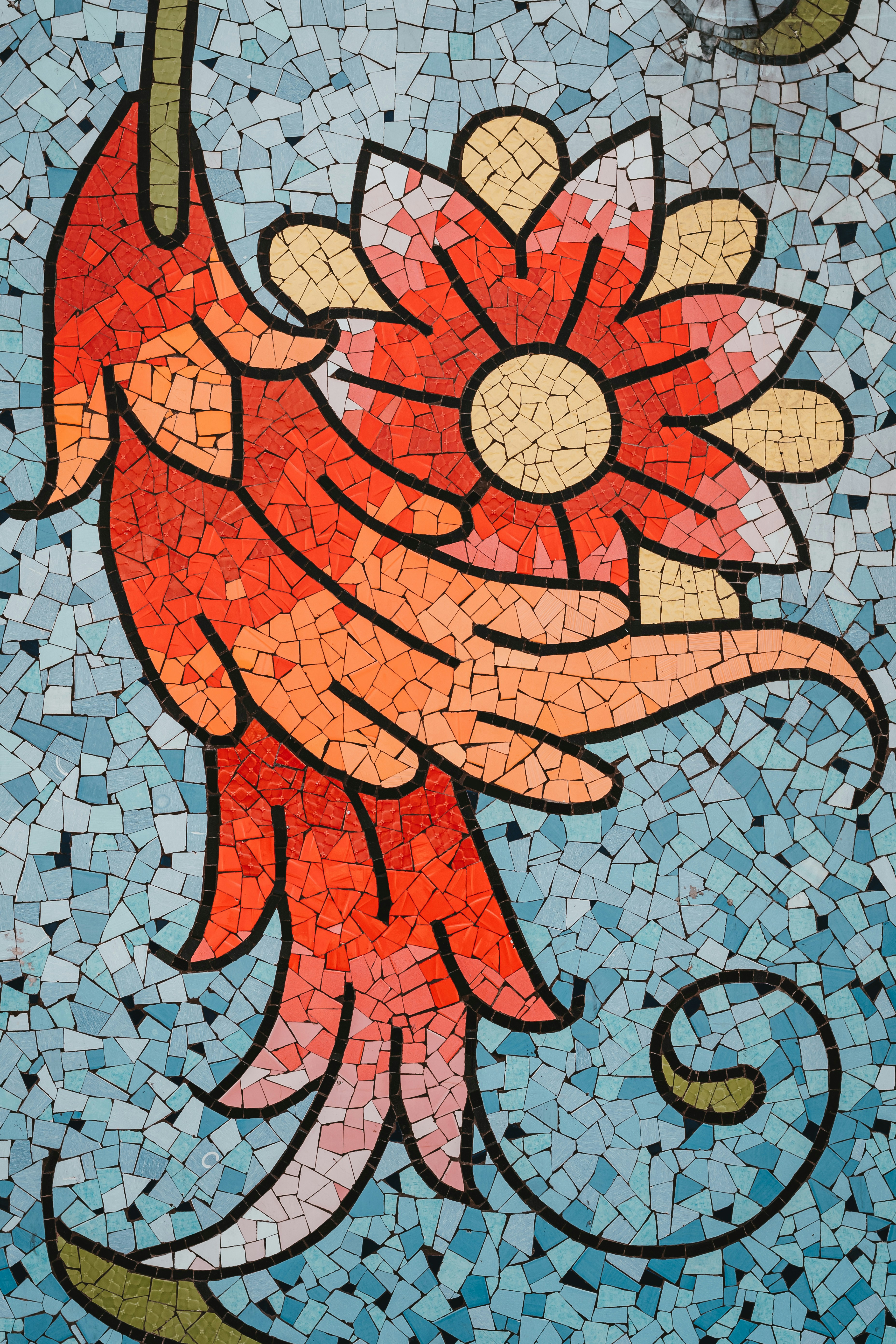 Colorful mosaic design featuring a stylized flower and leaves against a blue background.