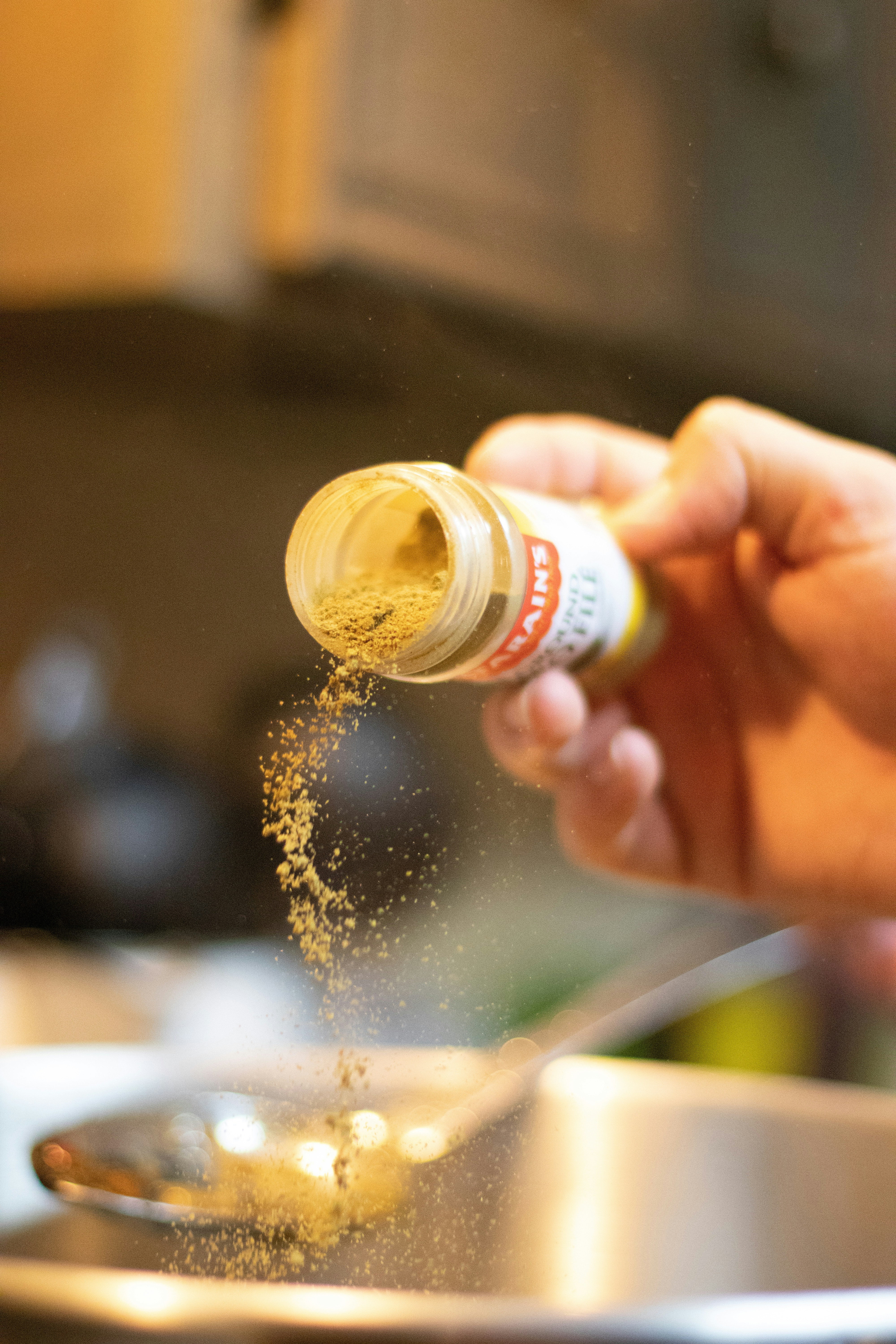 person holding white and brown plastic bottle