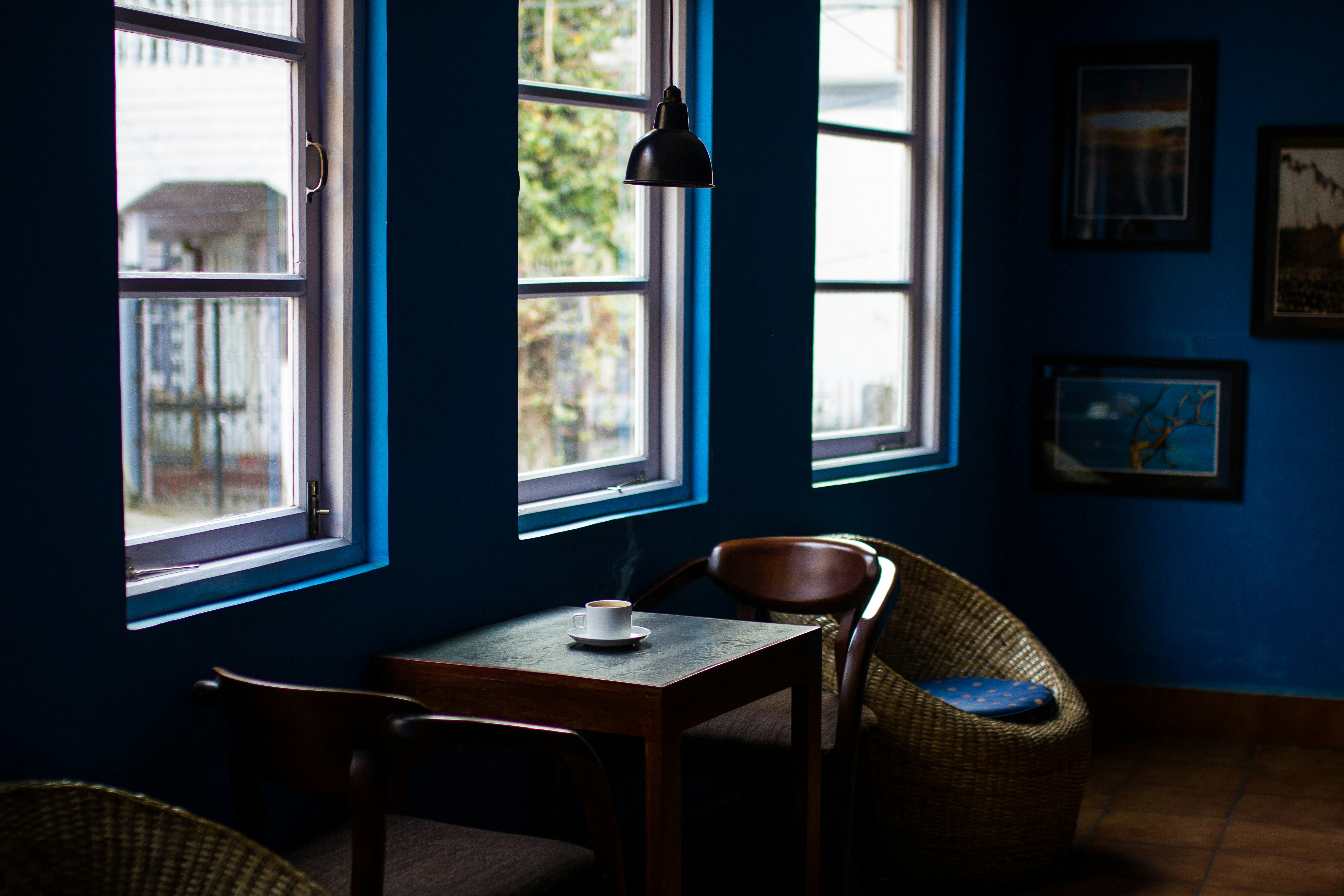 Sunlit Windowtable: A Blue-Walled Café Moment
